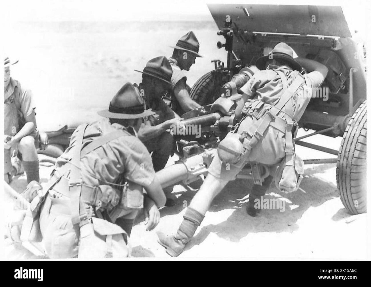 NEW ZEALAND ARTILLERY HAVE BATTLE PRACTICE IN DESERT. - Loading one of ...