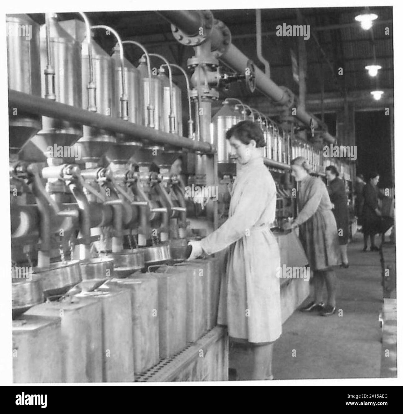 ATS personnel operate semi-automatic machines to fill petrol cans at a ...