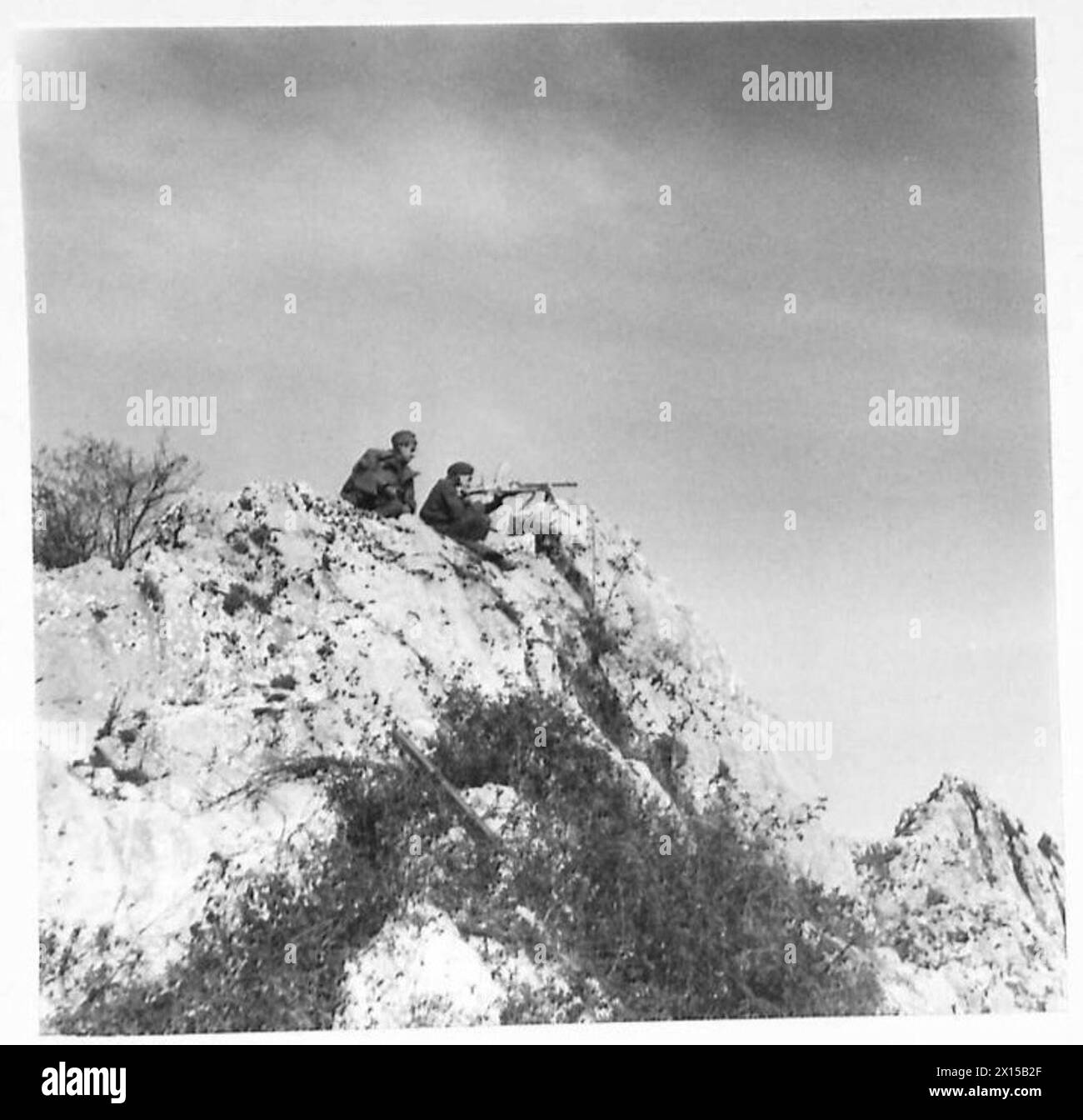 Partisan fighters in Yugoslavia position themselves on rocky terrain to ...