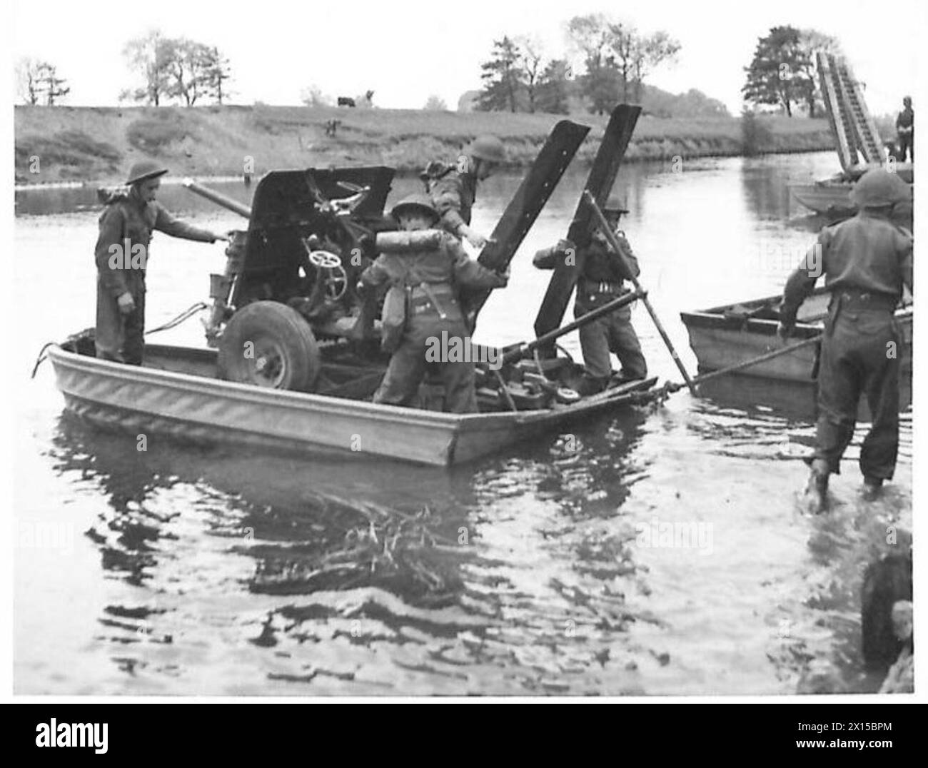 GETTING ACROSS RIVERS - A two pounder anti-tank gun is ferried across a ...