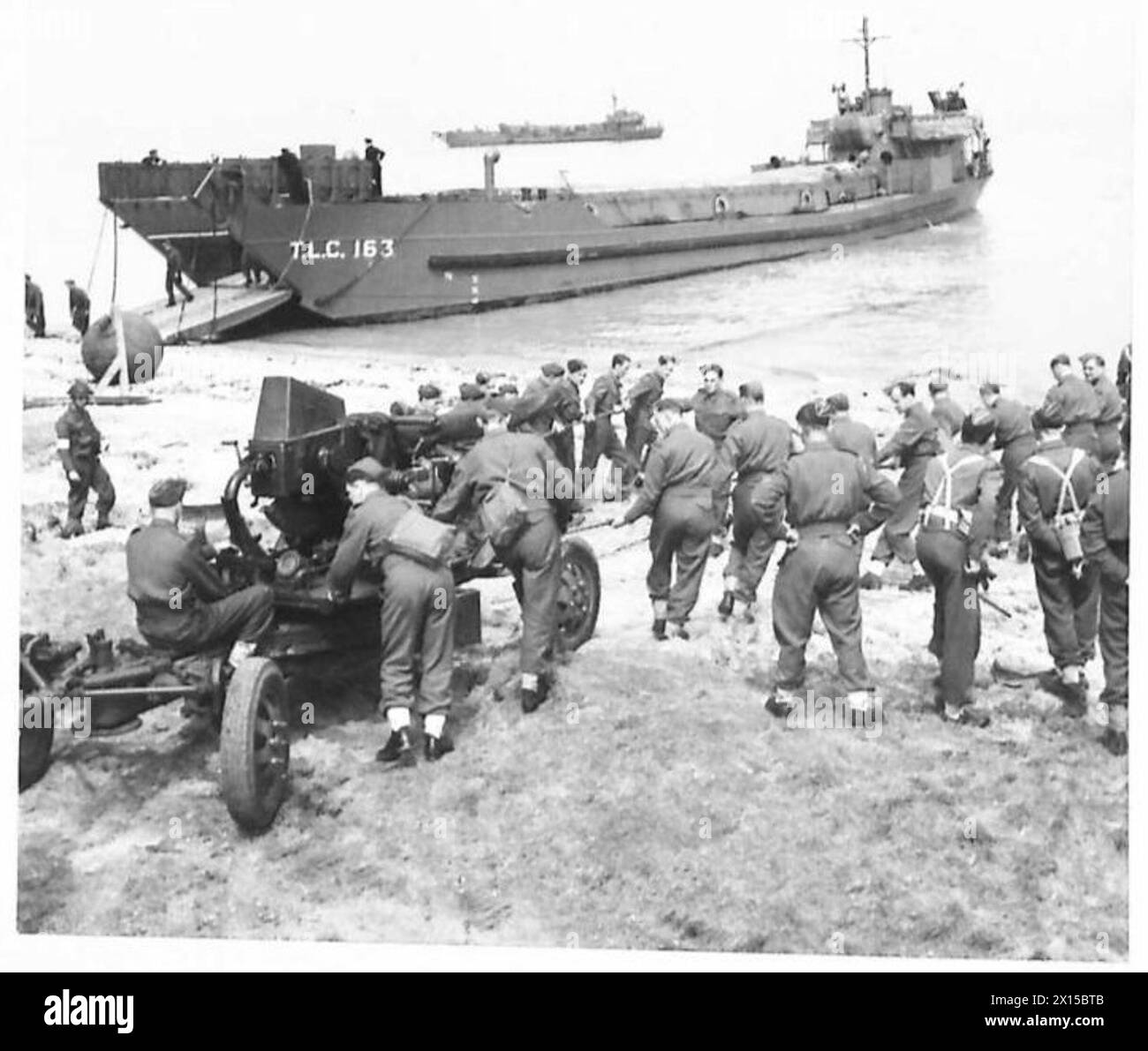 TANK LANDING CRAFT IN ACTION - Bofors AA guns being loaded onto tank ...