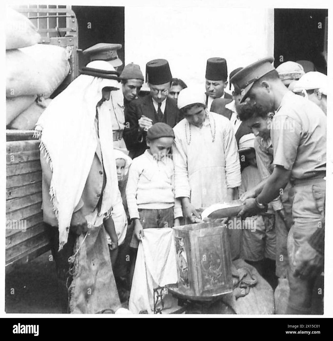 BRITISH ADVANCE INTO SYRIA - A British soldier measuring out the flour ...