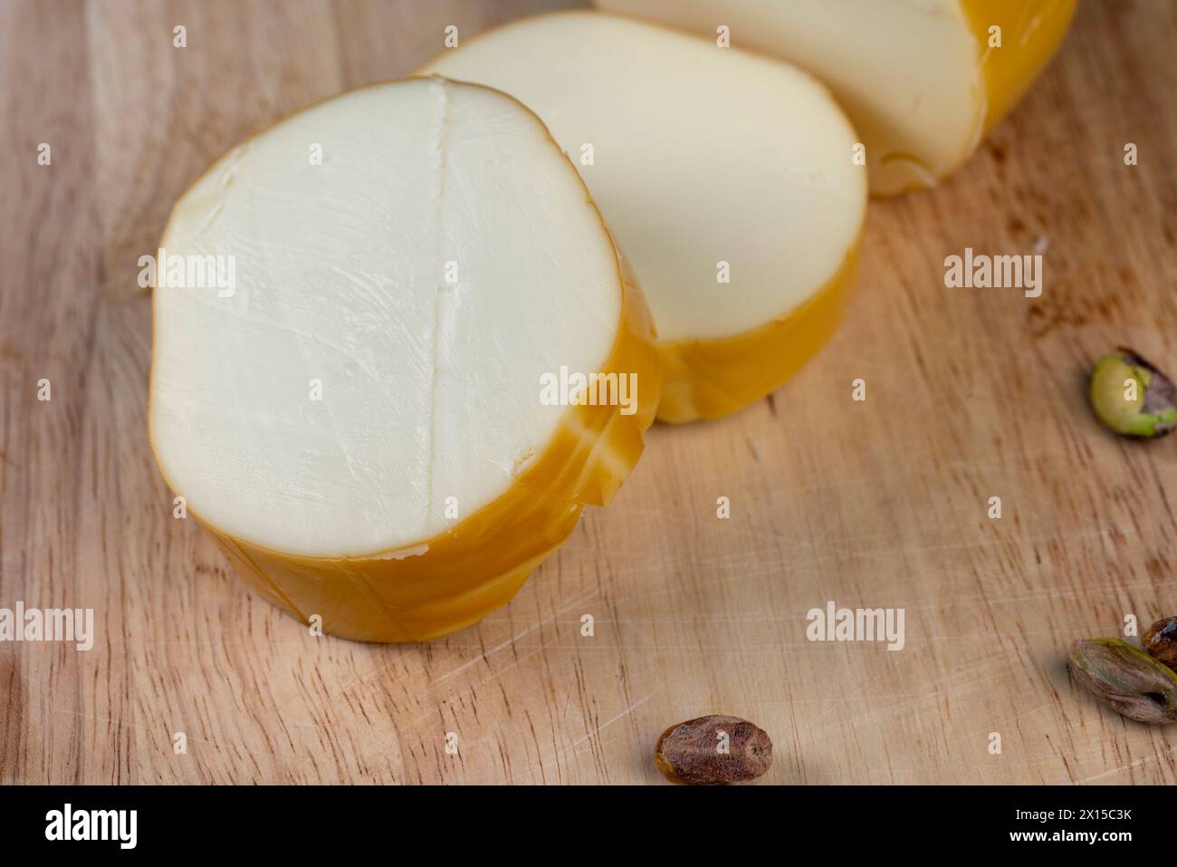 round processed cheese on the table, sausage cheese made from cow's ...