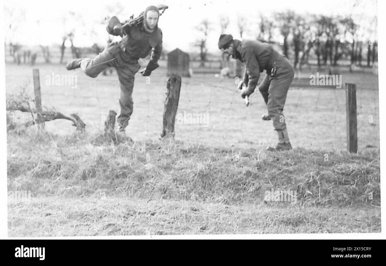 Parachute troops retrieve arms from a dropped equipment container and ...