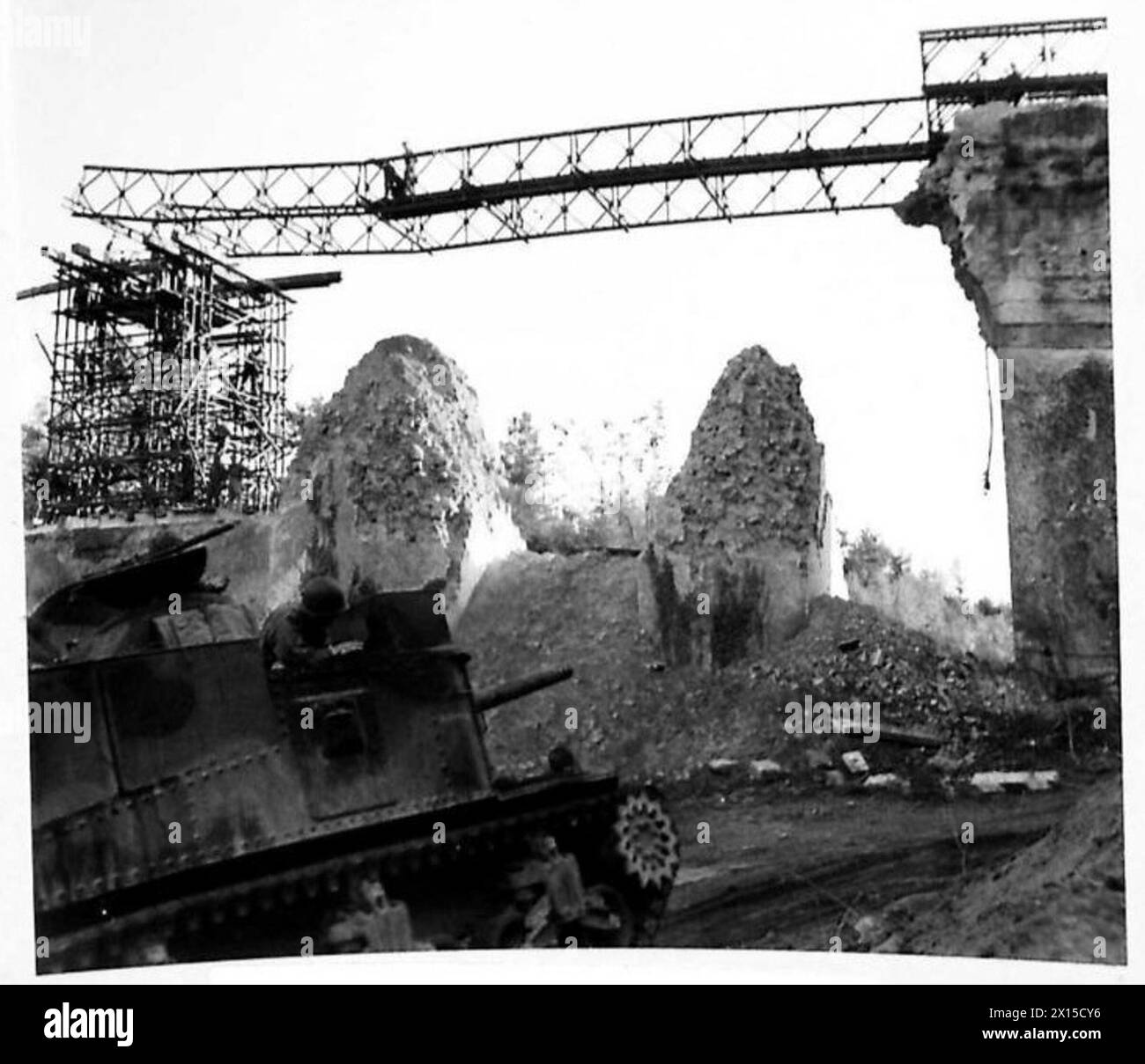 Six miles south of Teano, an enemy-destroyed bridge is partially ...