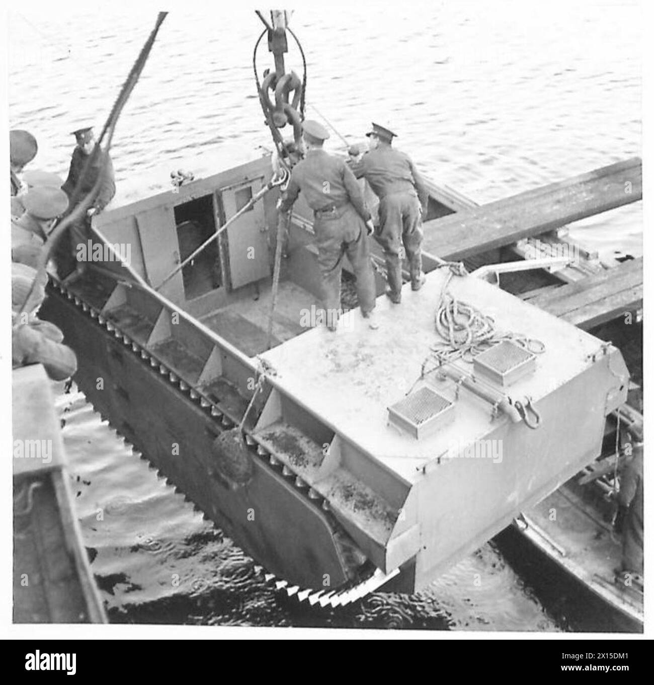 An amphibious Alligator vehicle is loaded onto a barge in preparation ...