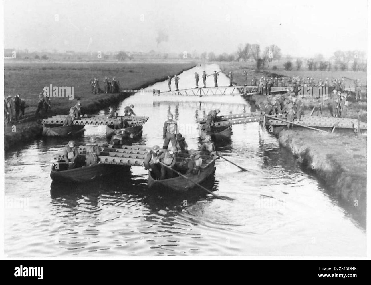 Centre sections of a bridge being rowed into position during a British ...