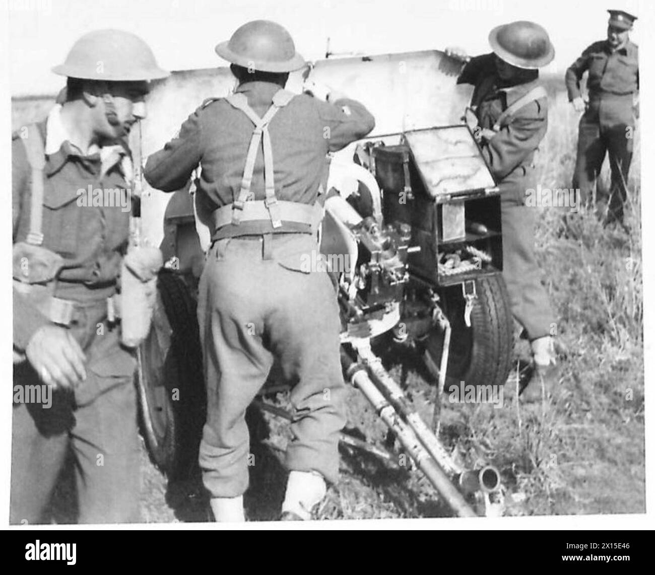 Greek Army personnel are preparing an anti-tank gun for firing during a ...