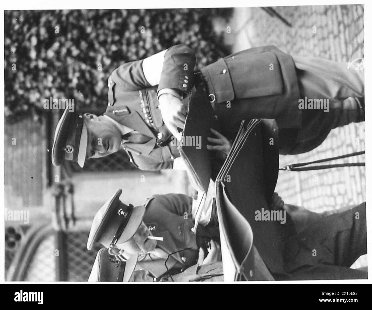 Major General E.B. Burrows reviews maps for operational planning within ...