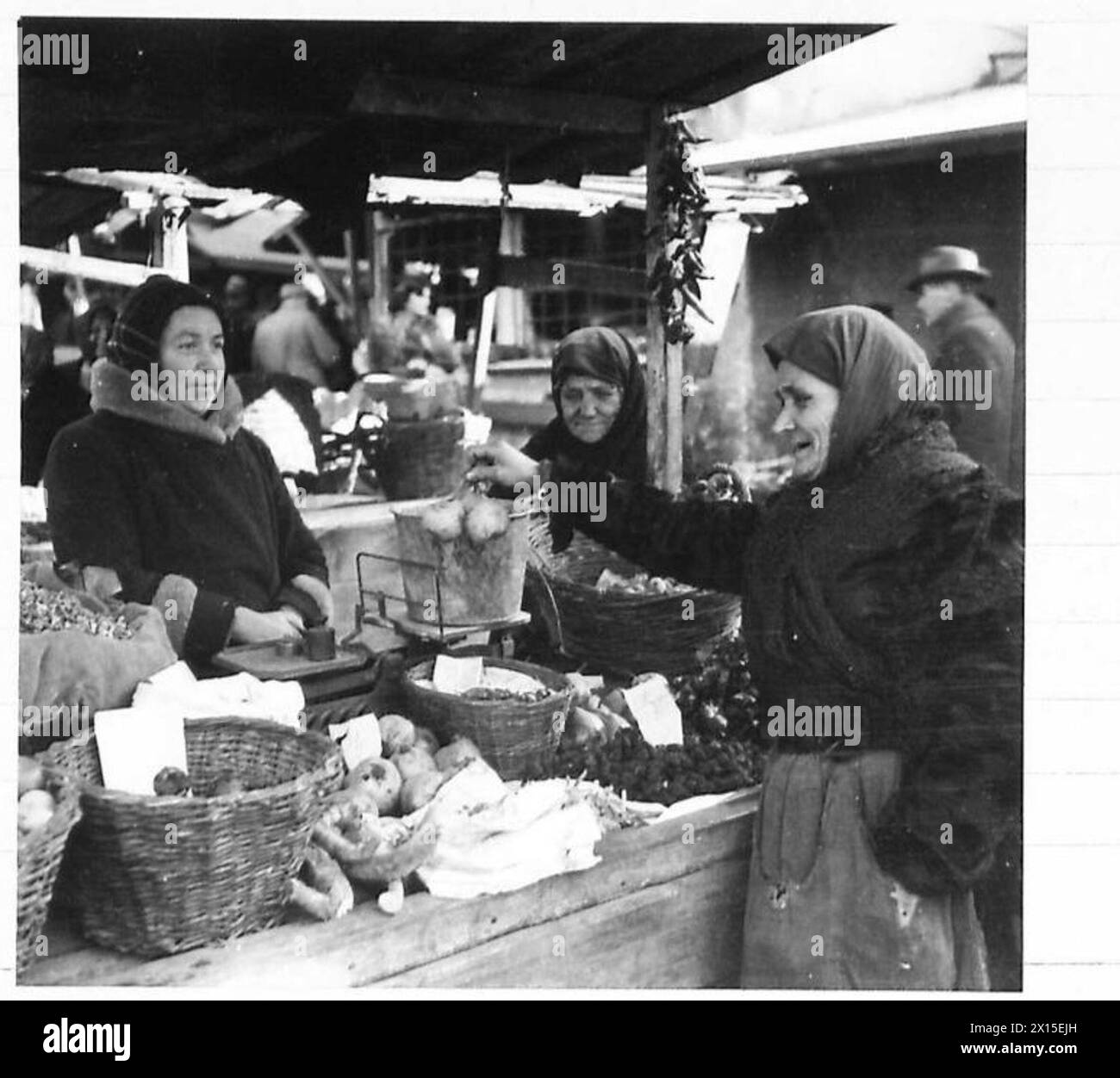 BELGRADEMARKET SCENES - A peasant woman buys from one of the market ...