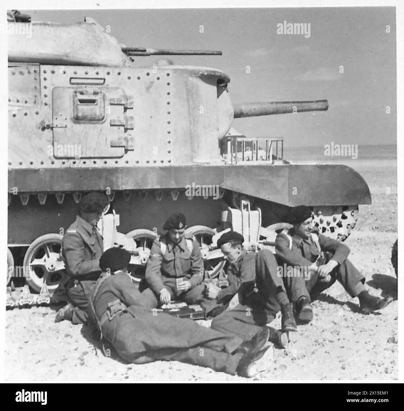 Crew members of an American 'General Grant' medium tank take a rest ...