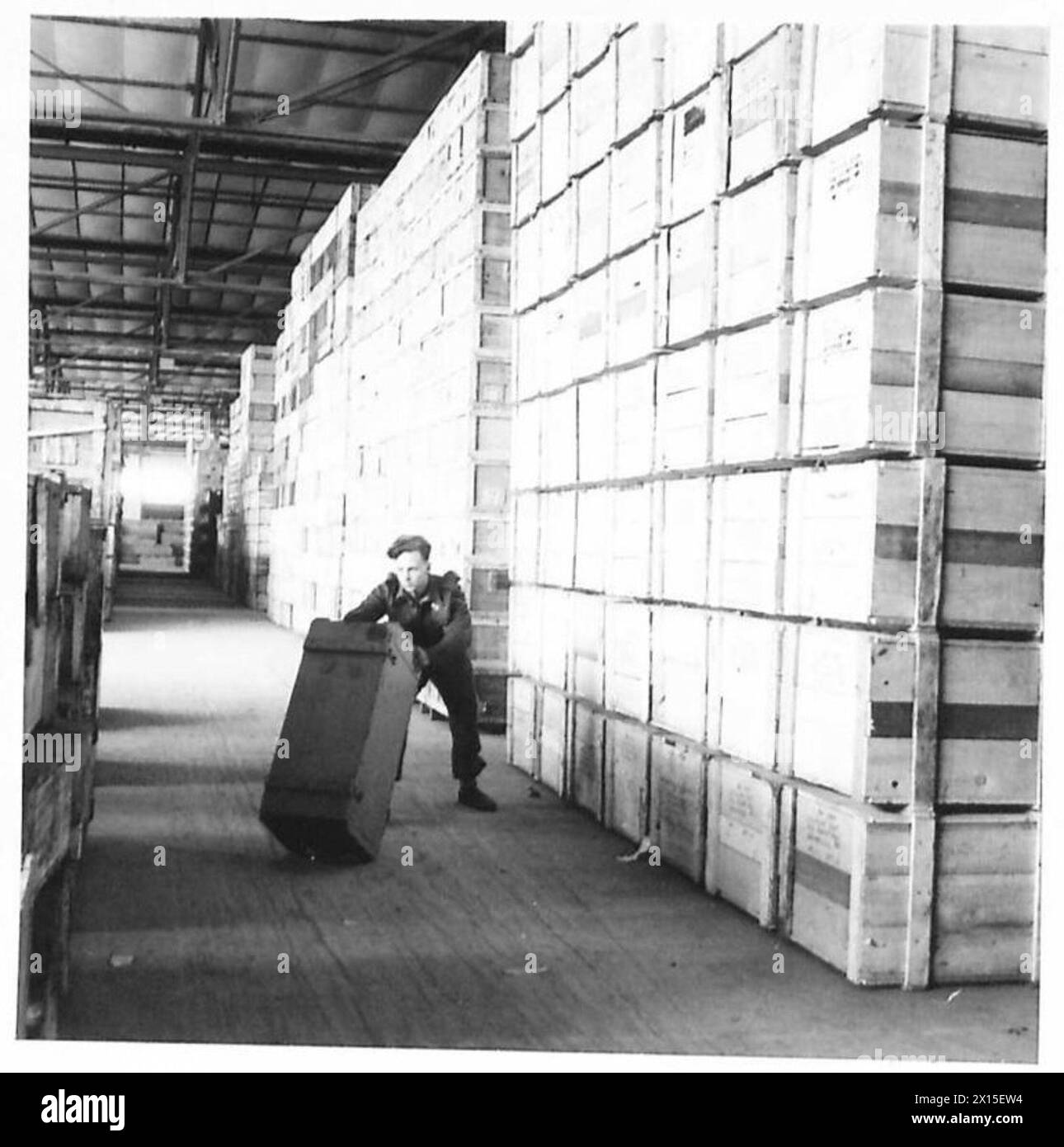 Stacks of packing cases contain rifles, Bren guns, 20mm guns, and PIAT ...