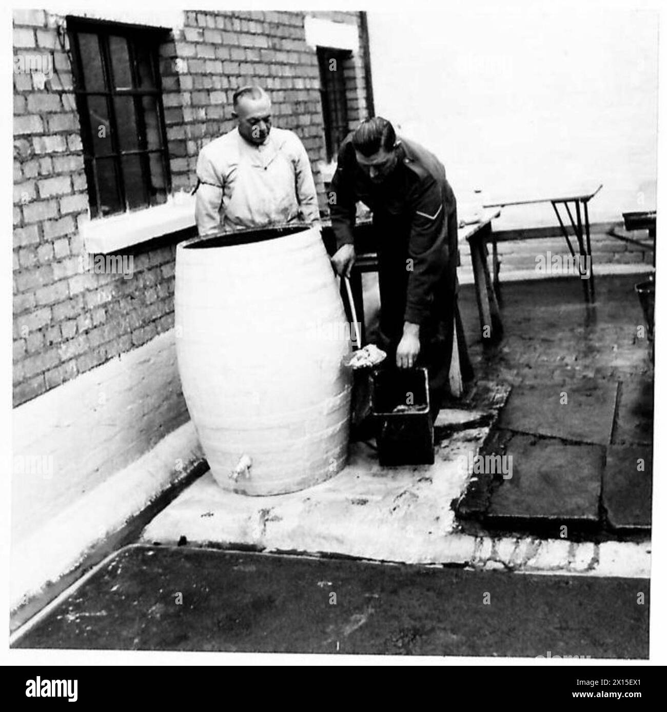 SALVAGE - Grease is retrieved from a barrel where greasy water is ...