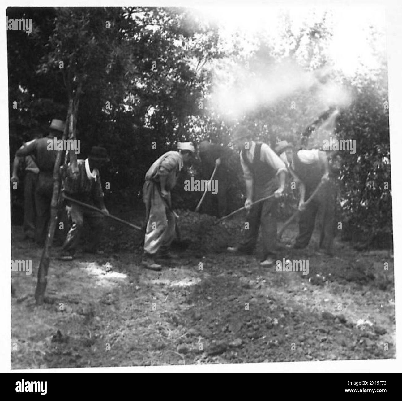 Grave-diggers remove soil from an unopened grave in San Polo ...