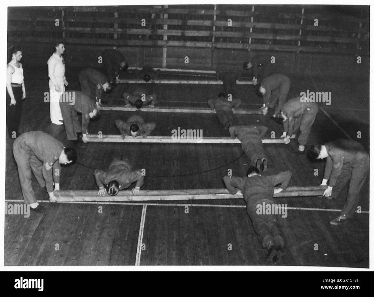 TRAINING P.T. INSTRUCTORS - A class undergoing exercises with a heavy ...