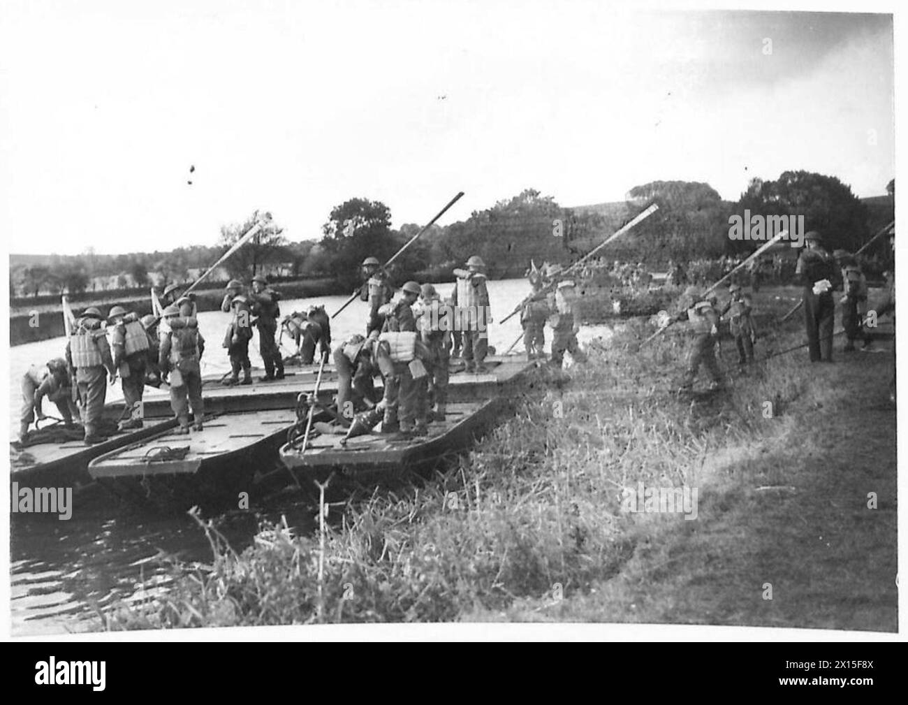THE ARMY'S BRIDGE BUILDERS - The oarsmen go aboard a section of the ...
