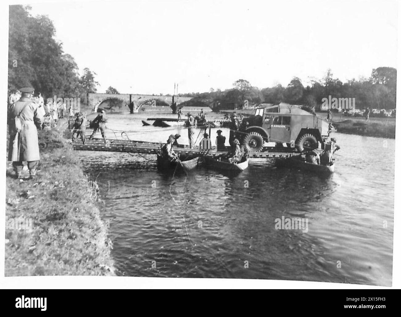 A lorry is transported across a river using a shore loading craft ...