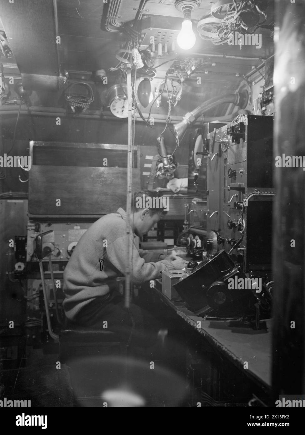 A radioman operates the wireless equipment in the HMS Tribune submarine ...