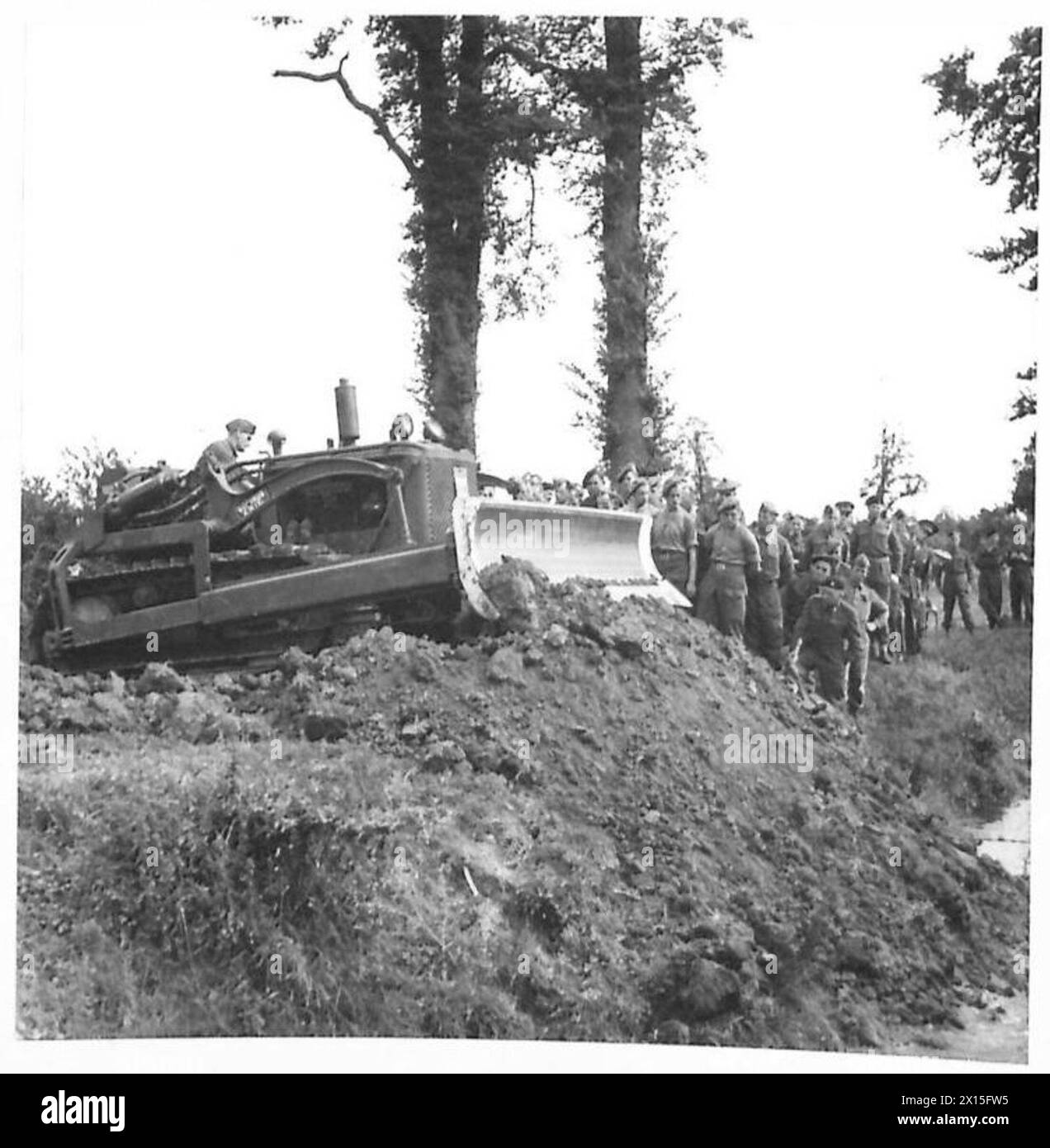 A bulldozer levels a bridge to assist British Army anti-tank equipment ...