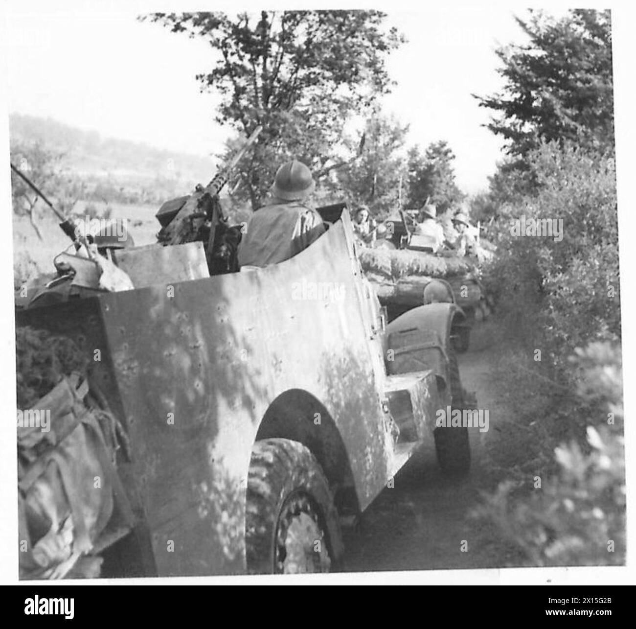 French 3rd Regiment of Spahis motorized troops advance toward a town as ...