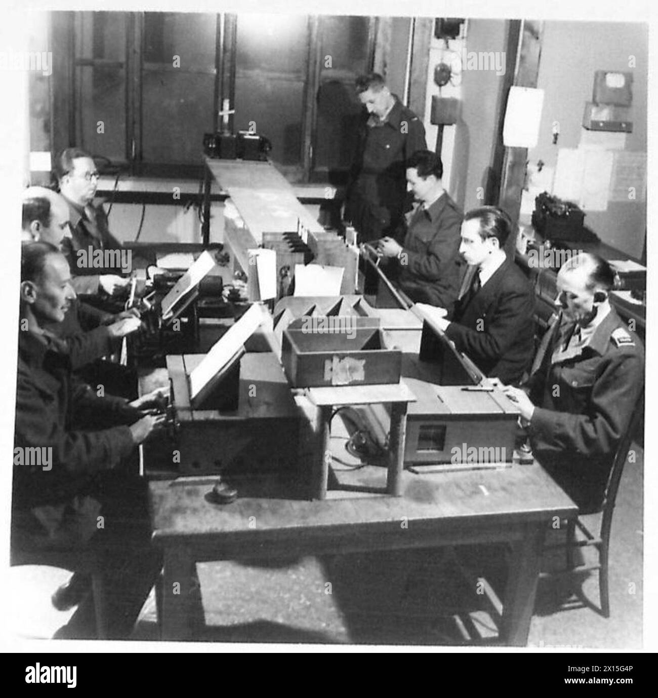 Military personnel operate the Cable & Wireless room in Italy, typing ...