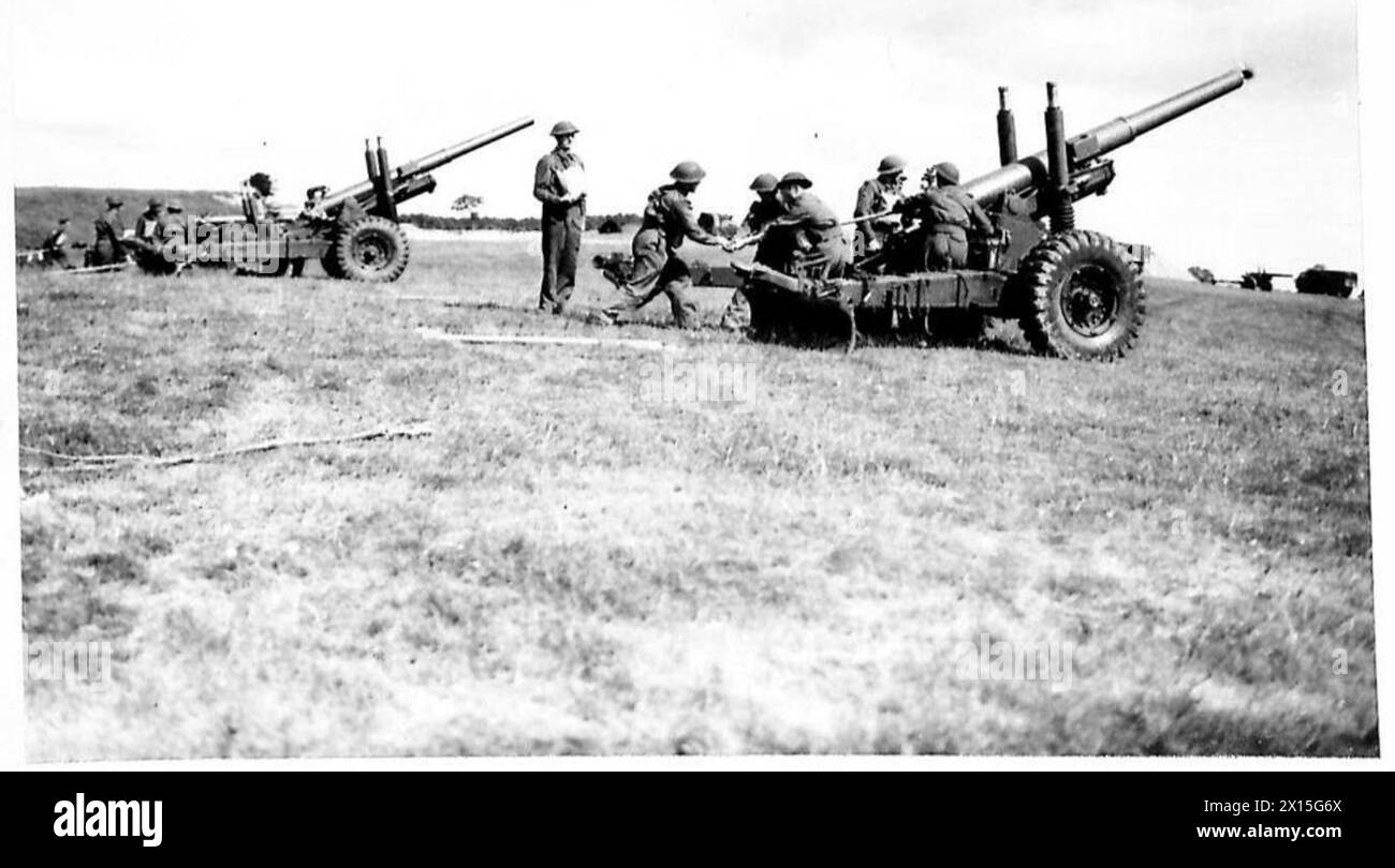 GUN HOWITZERS IN ACTION - The shell being rammed home in the breech ...