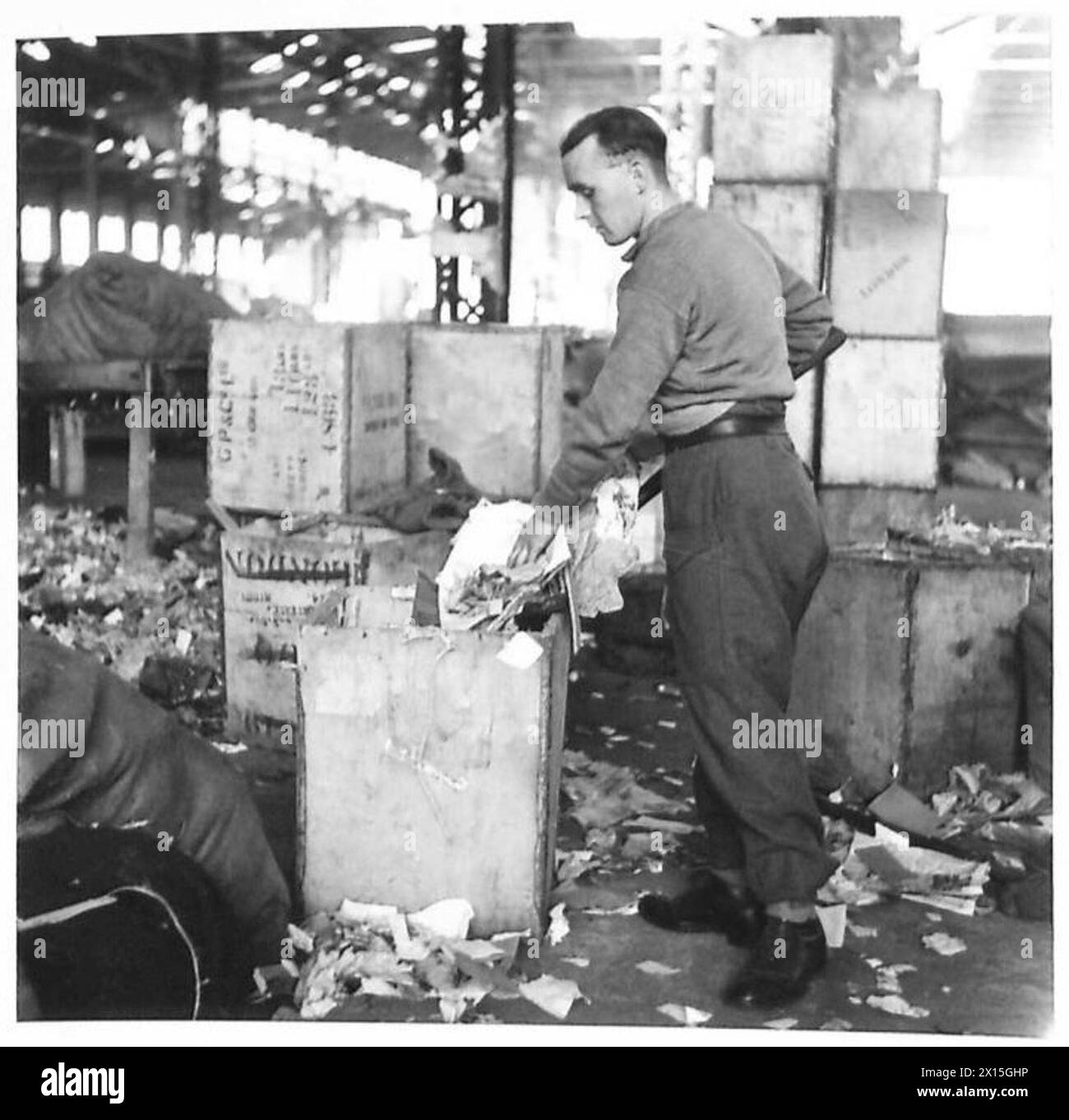 British Army personnel are shoveling and boxing paper scraps as part of ...