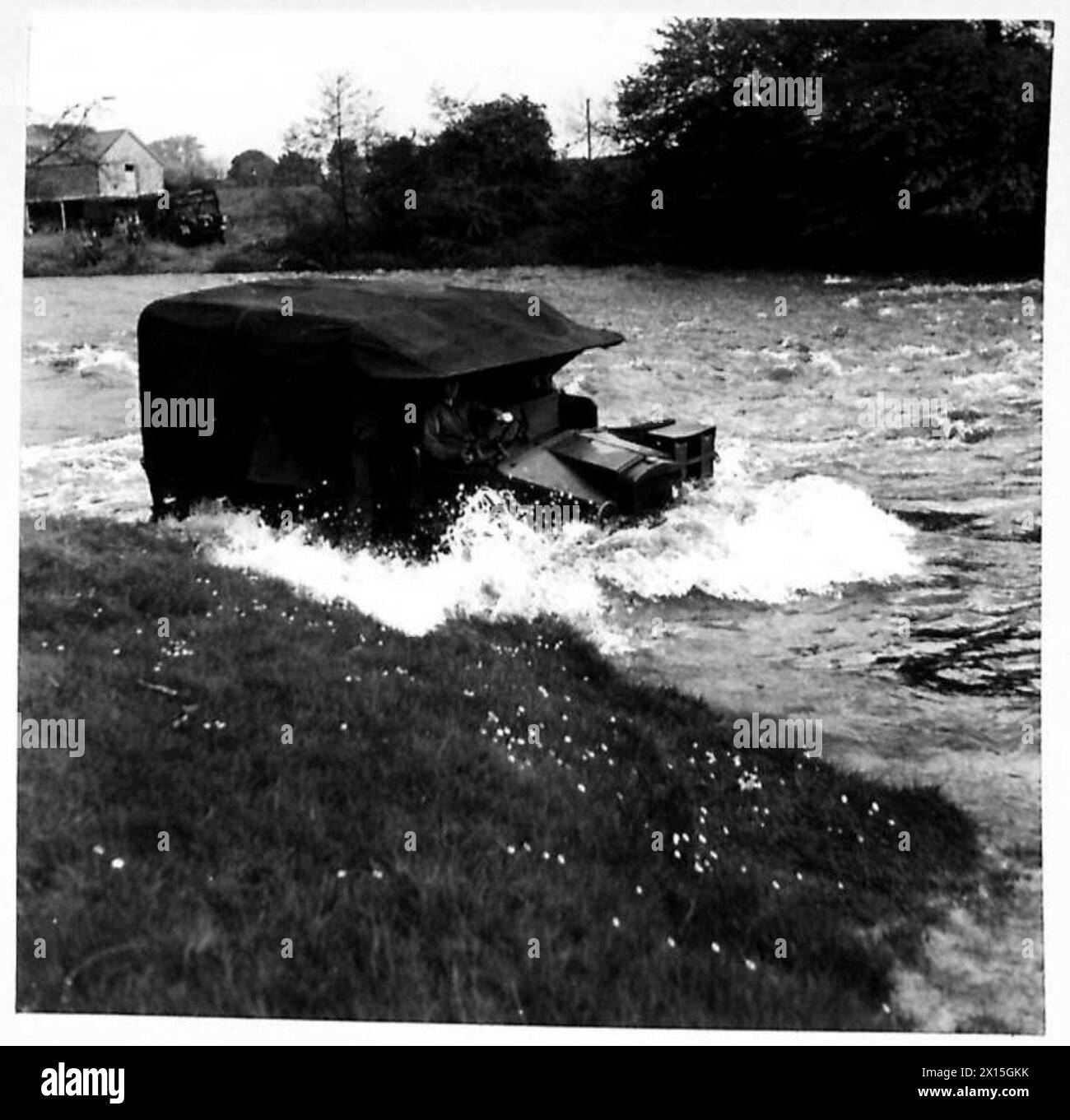 GETTING THE GUNS ACROSS - An anti-tank gun tractor crossing a river ...