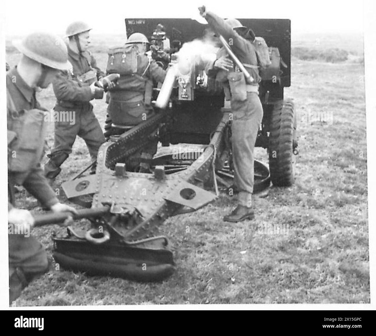 NEWFOUNDLAND TROOPS TRAIN IN ENGLAND - An empty shell case is ejected from the breech, while the ...