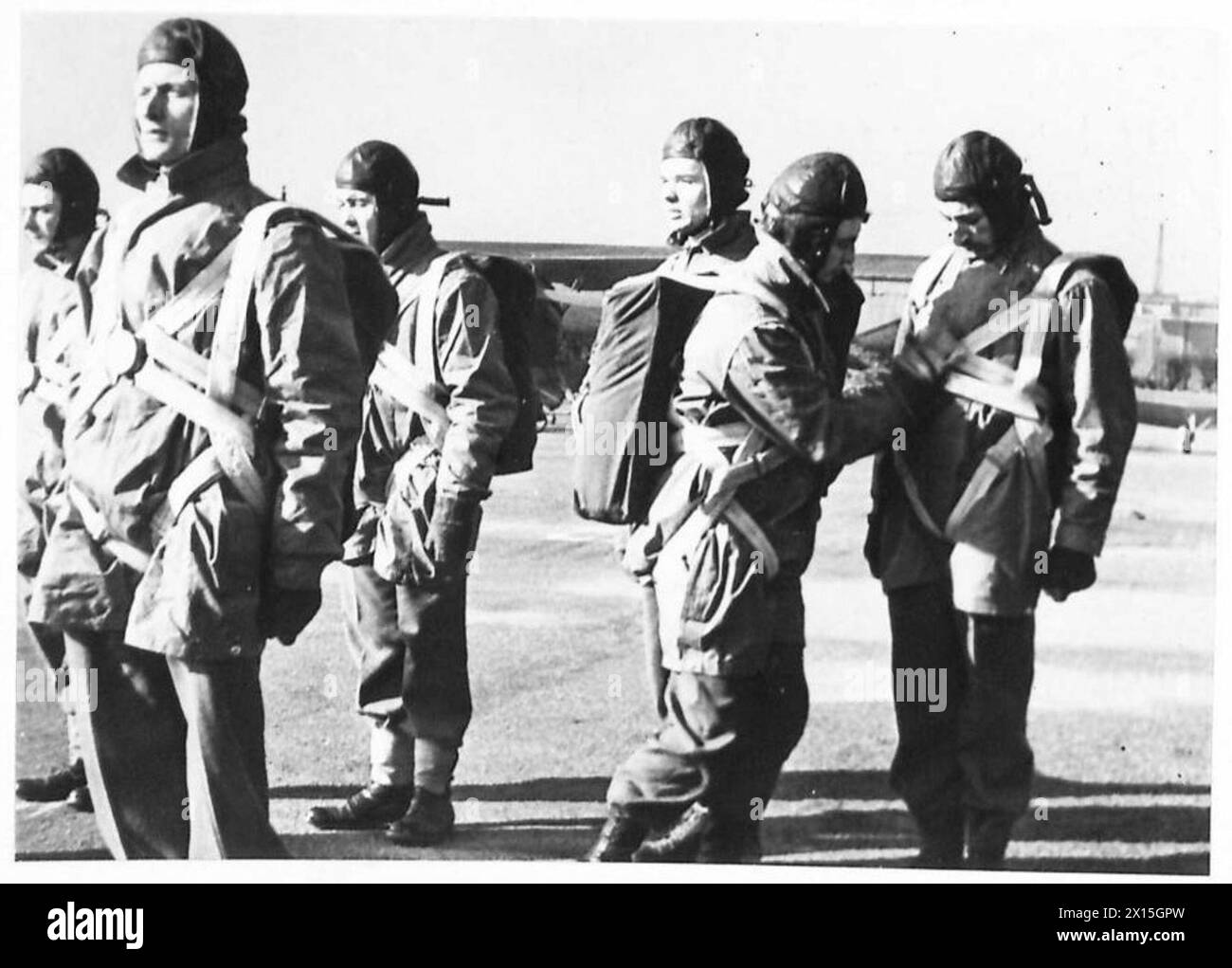 BRITAIN'S PARACHUTE TROOPS IN TRAINING - Before a flight their harness ...