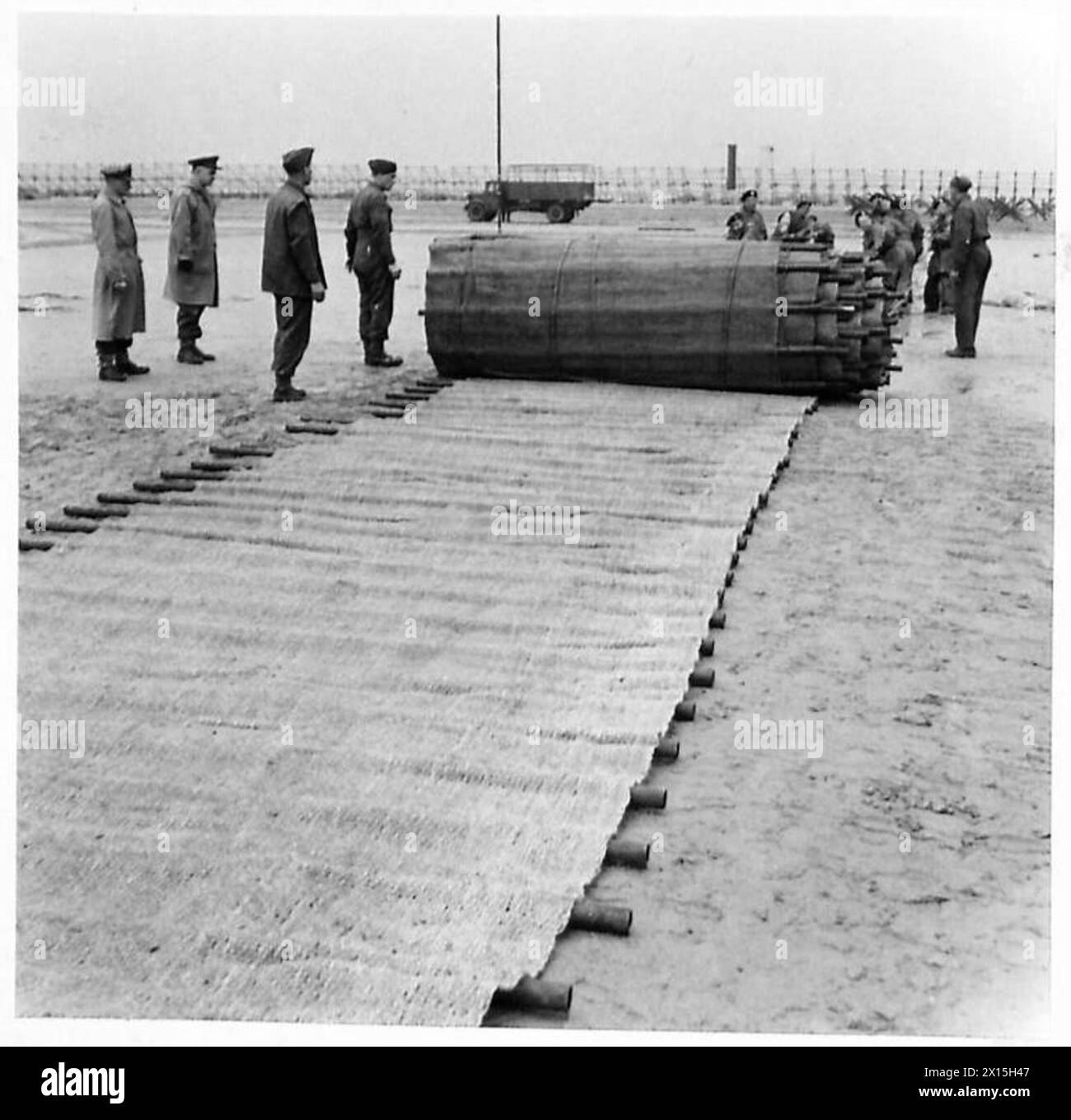 Flail tanks of the 79th Armoured Division deploy a mat-laying device ...