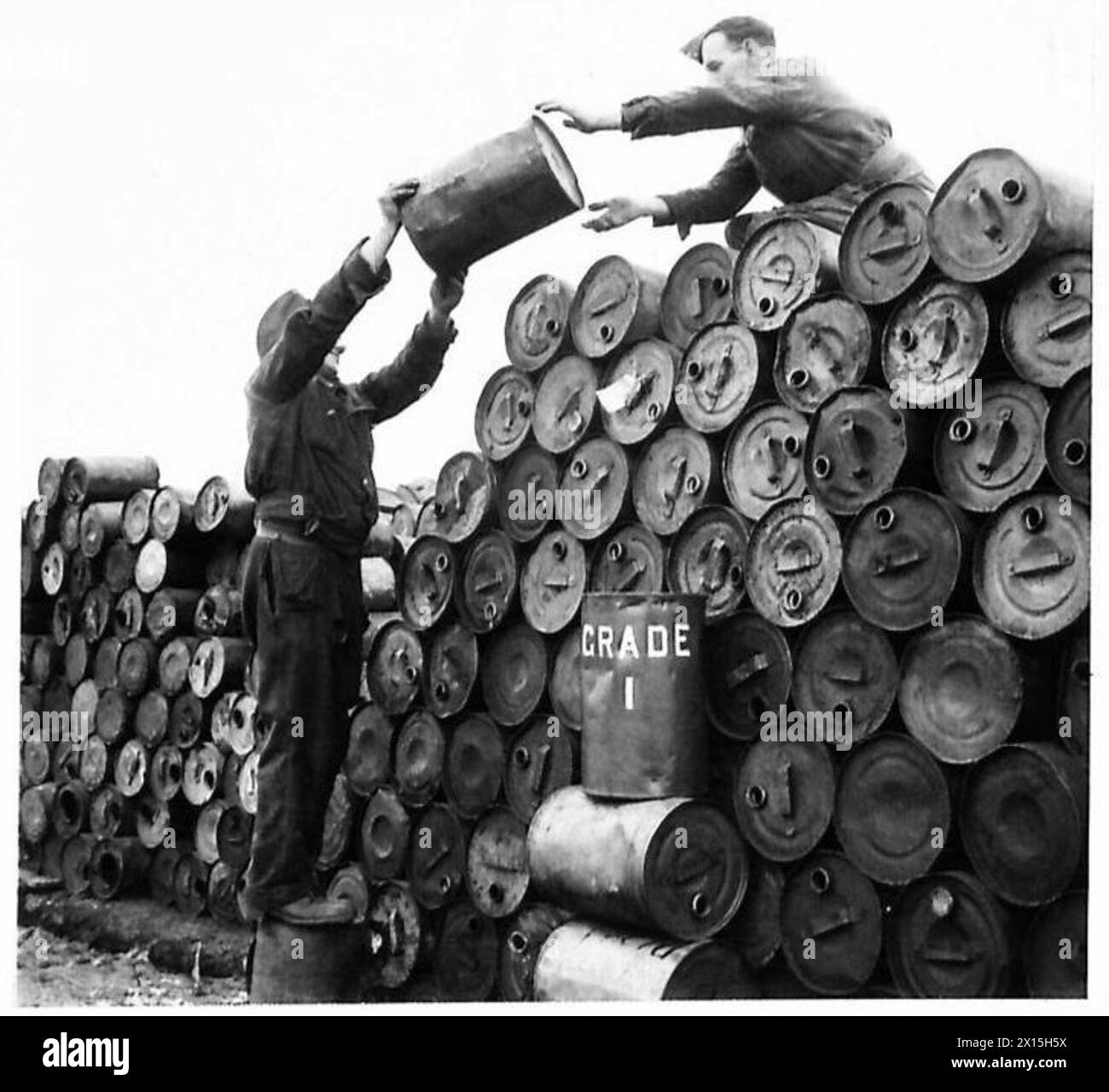 AT A NORTHERN IRELAND ARMY SALVAGE DEPOT - Stacking up 5-gallon oil ...