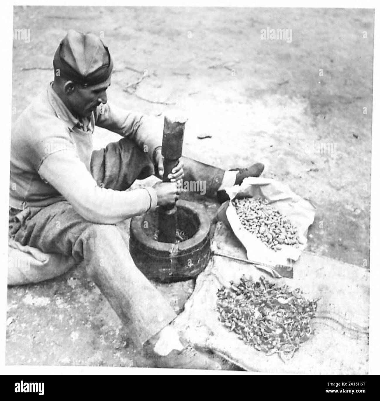 WITH THE ROYAL INDIAN ARMY SERVICE CORPS - An Indian cook mixing spice ...