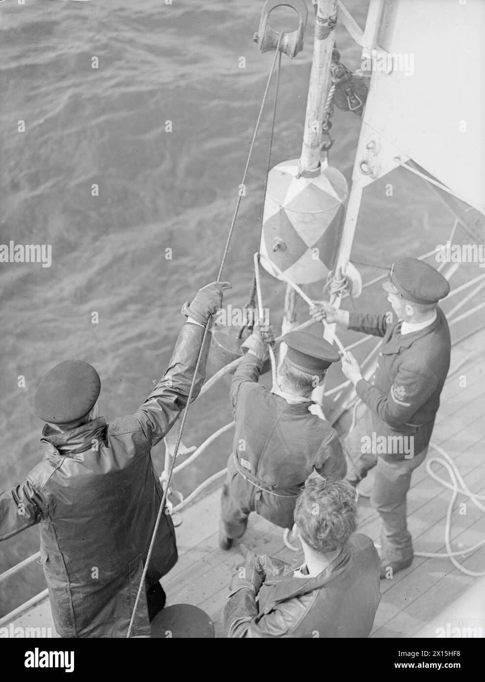 Crew members of a British Algerine-class minesweeper operating from HMS ...