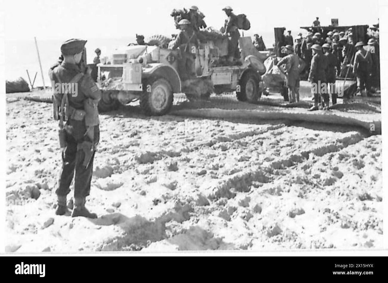 A vehicle and gun are landed ashore during a combined operations ...