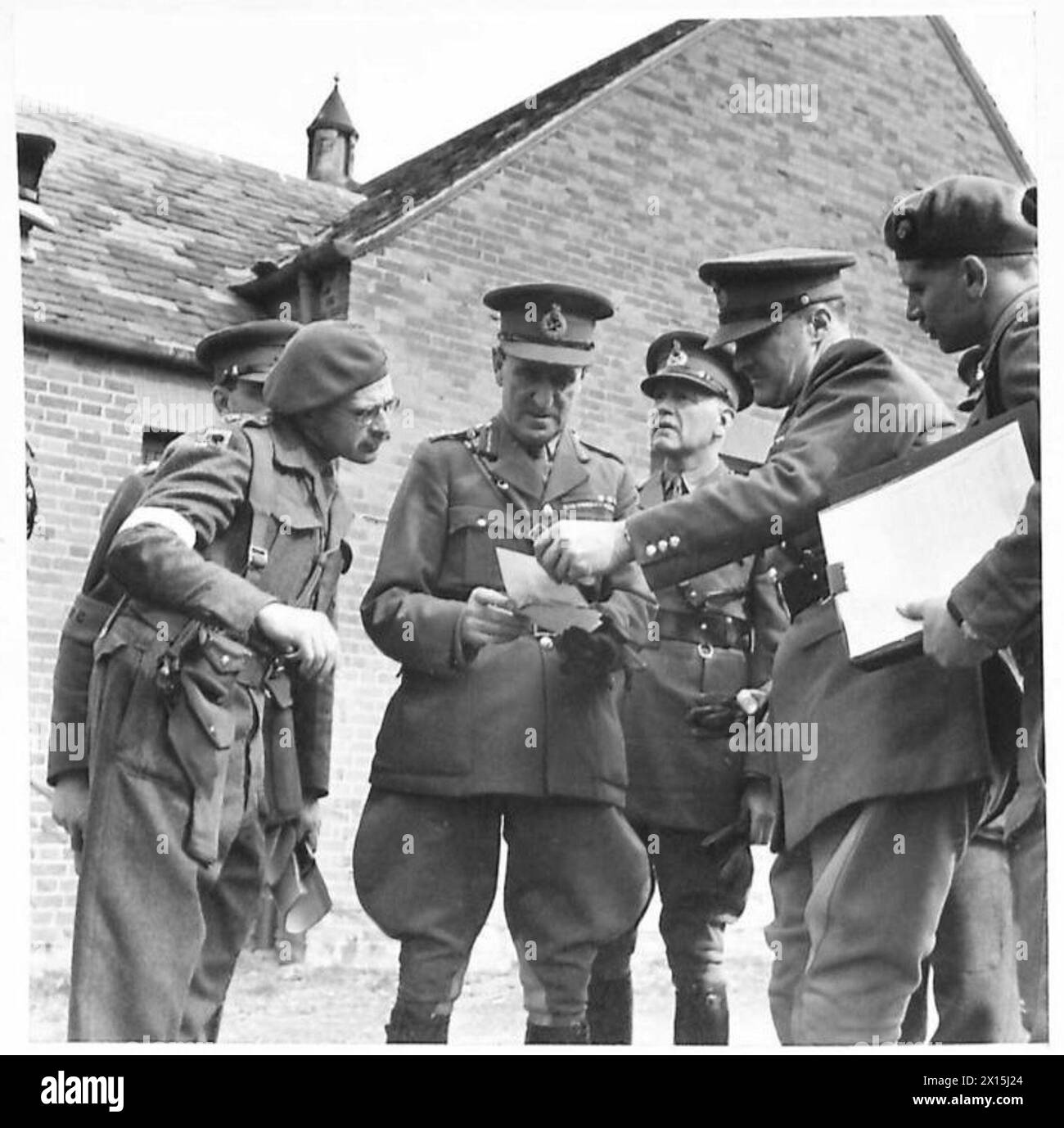 The Commander-in-Chief and Major General Burrows review documents ...