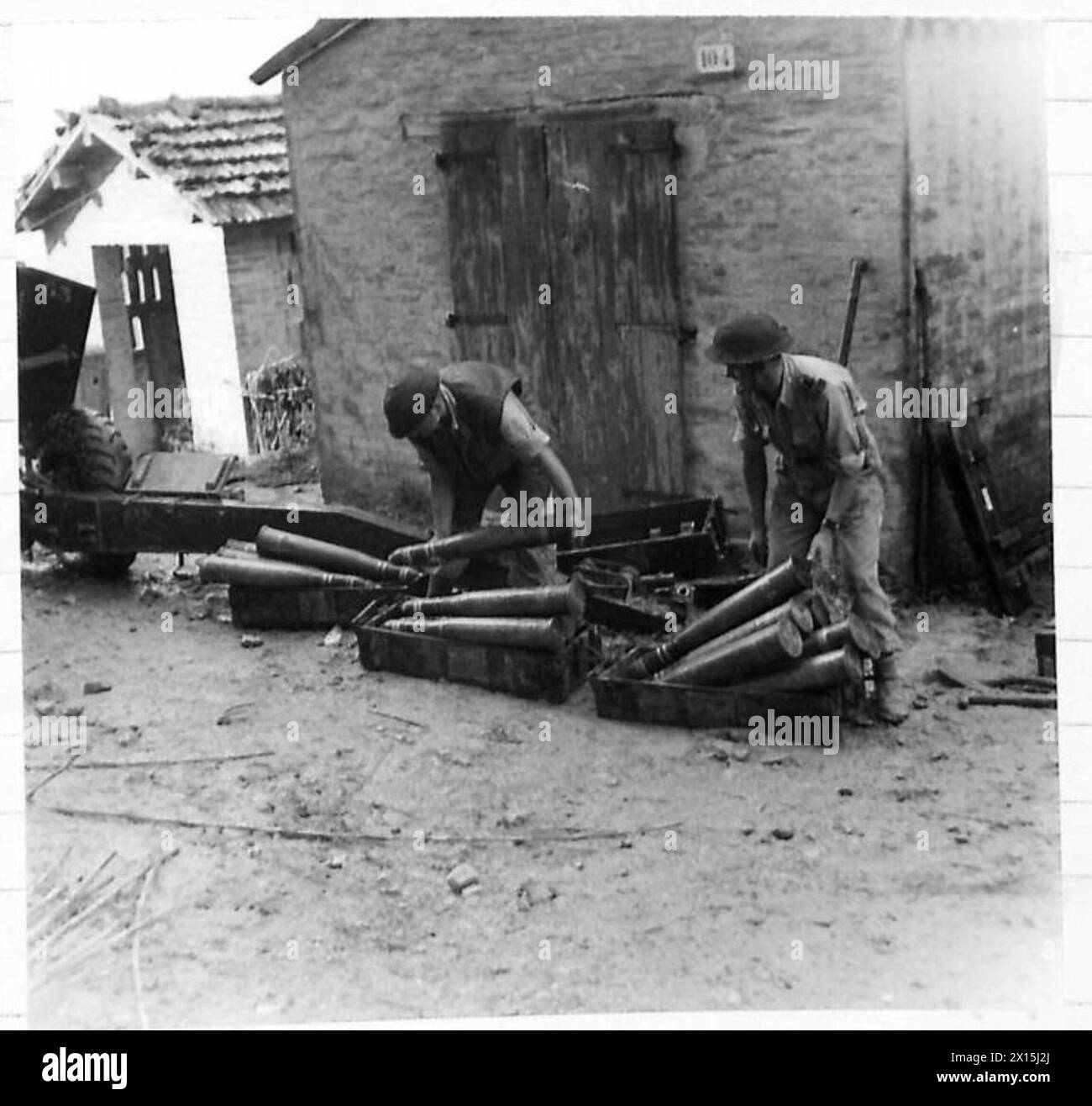 Gunners of a 17-Pounder anti-tank gun transport ammunition for a ...