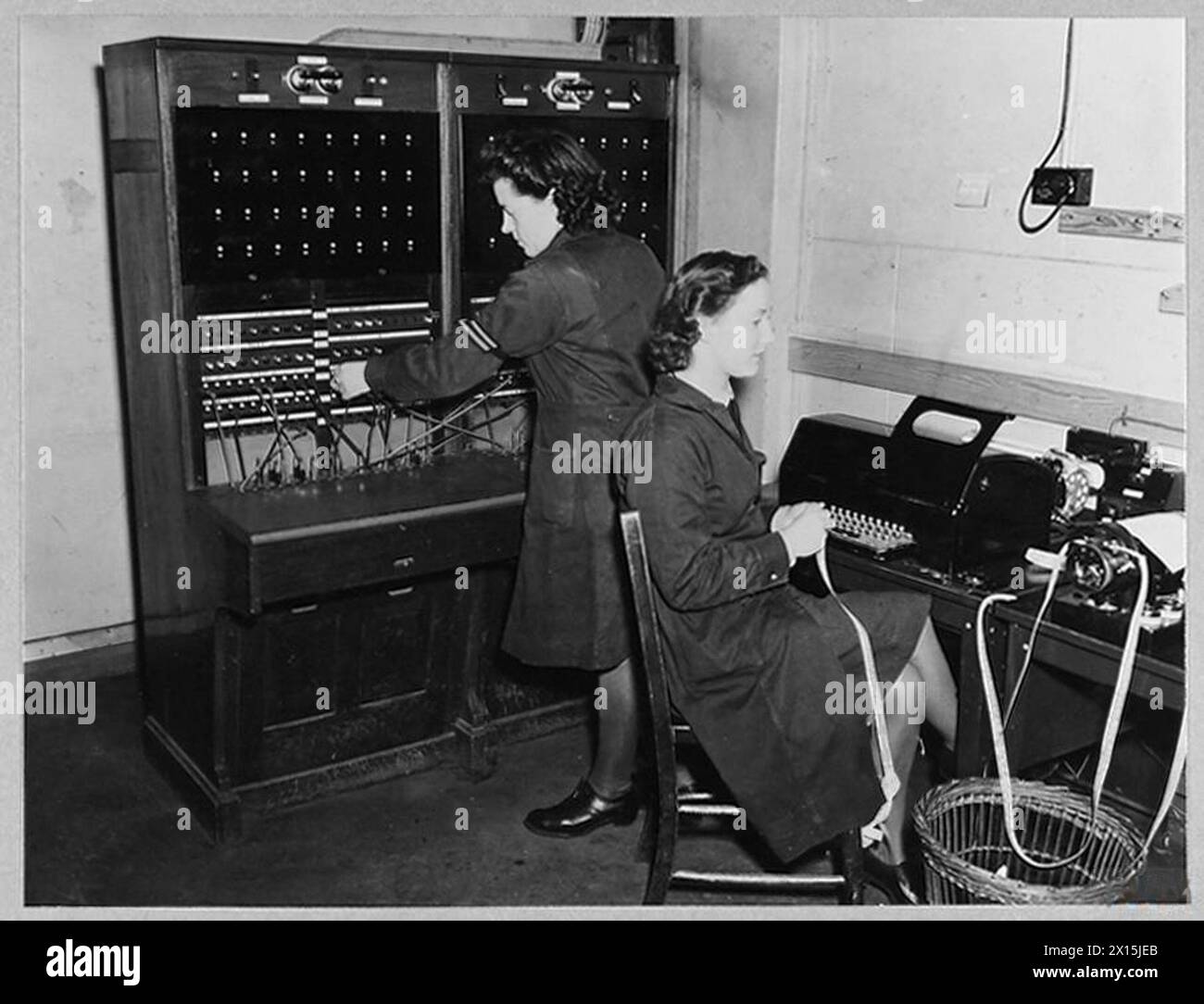 A W.A.A.F. corporal operates a concentrator at the Combined Control ...