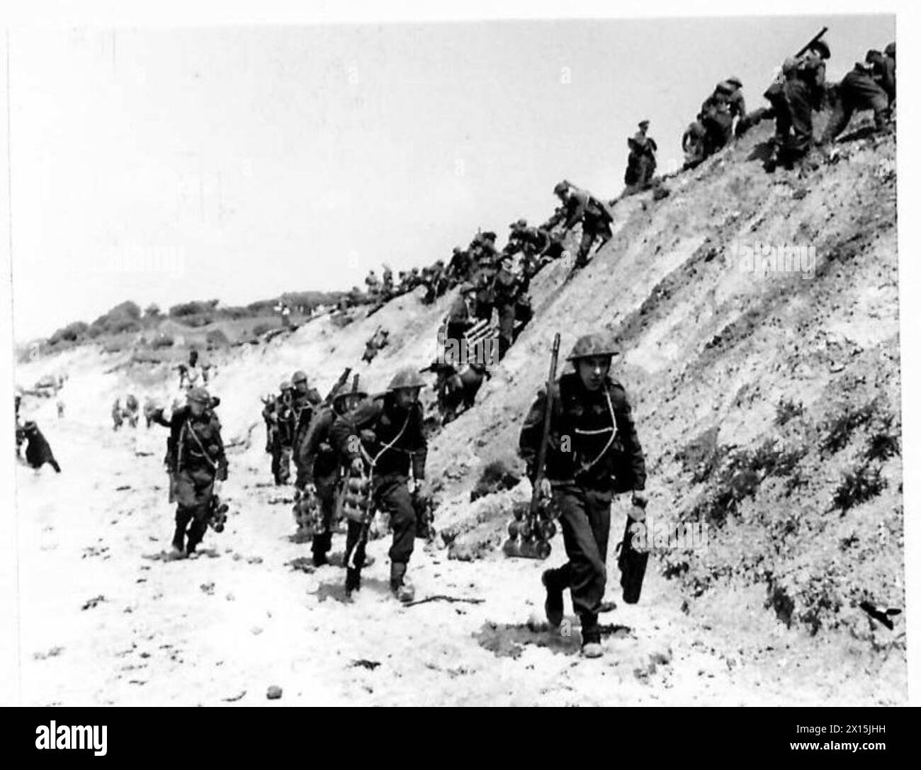 A LANDING EXERCISE - Troops carrying mortar shells after landing on an ...