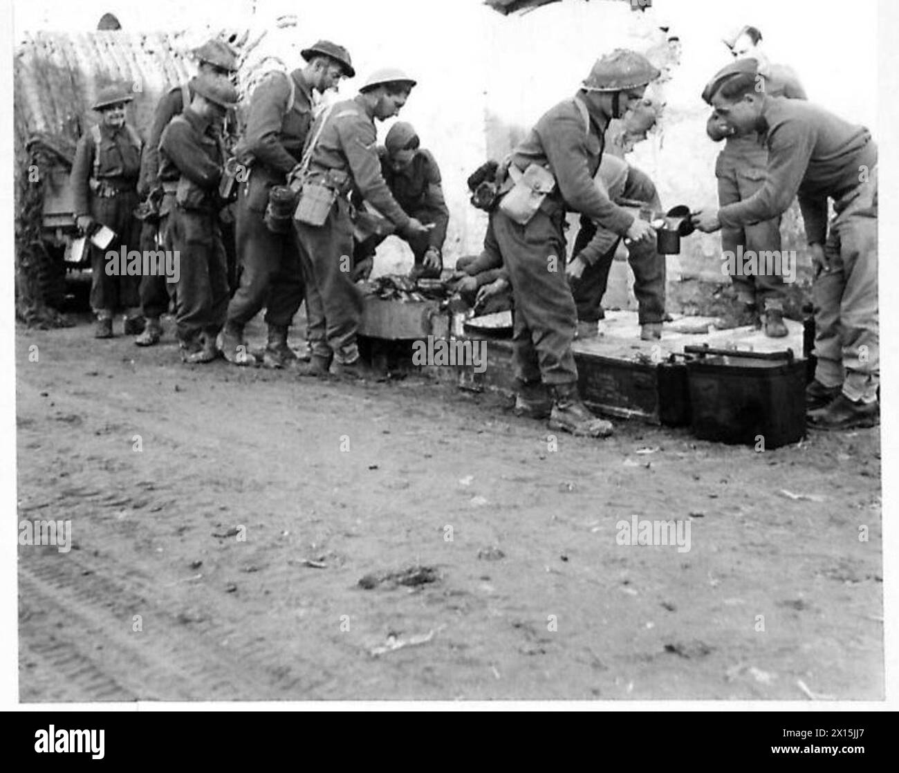 Infantrymen line up for hot meals during routine operations, British ...