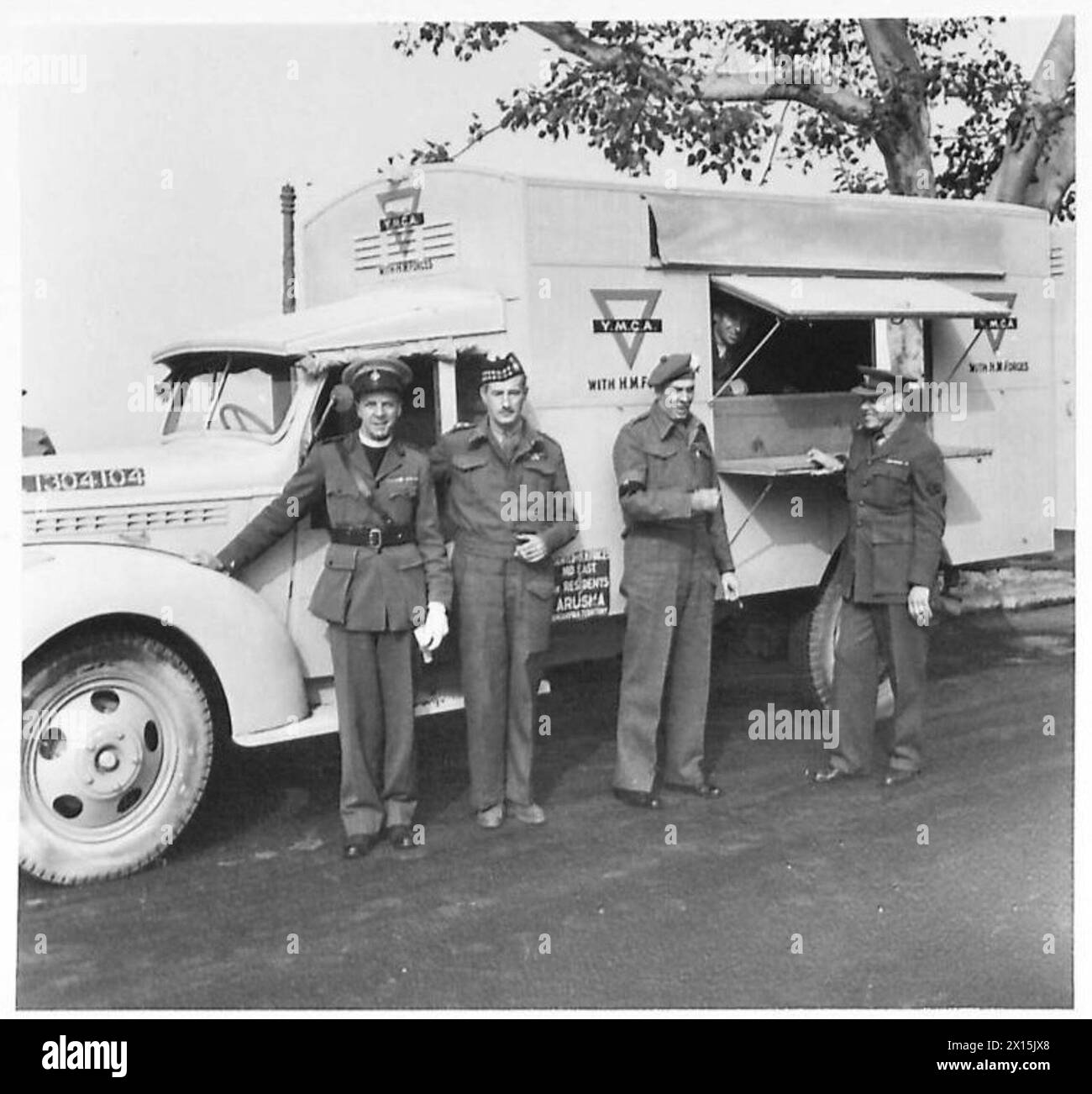 GIFT FROM TANGANYIKA - The Deputy Chaplain (left) with R.E. Staff ...