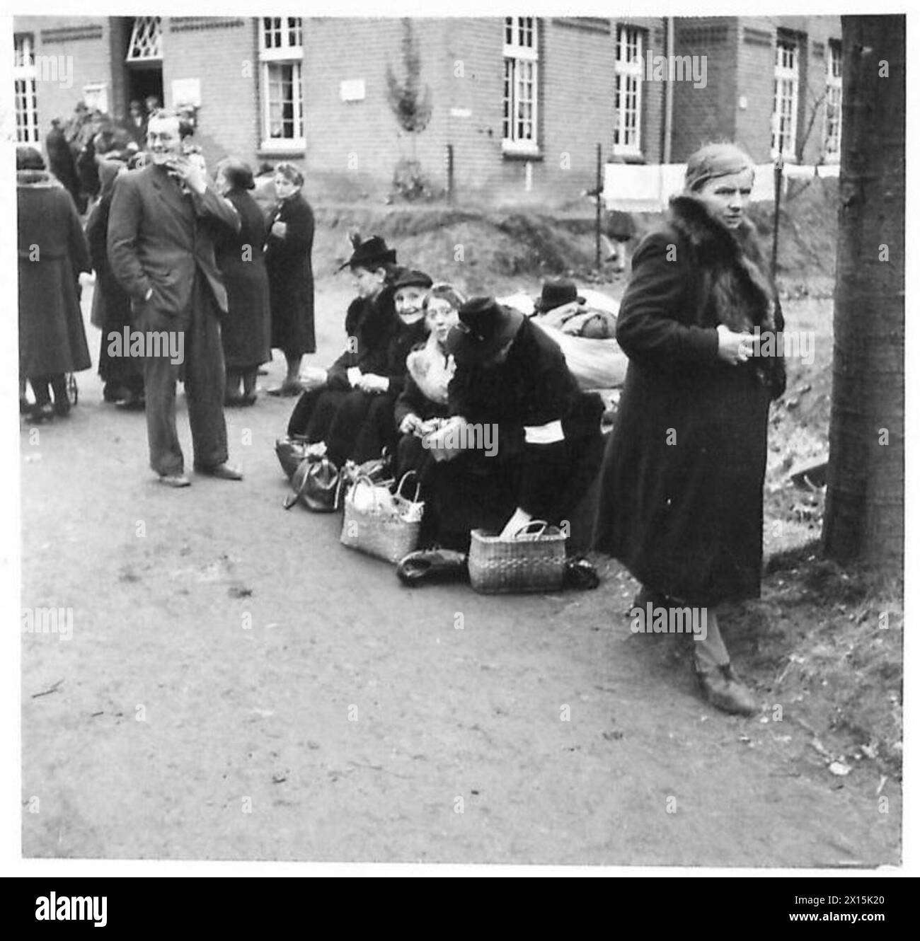 Civilians sit Black and White Stock Photos & Images - Alamy