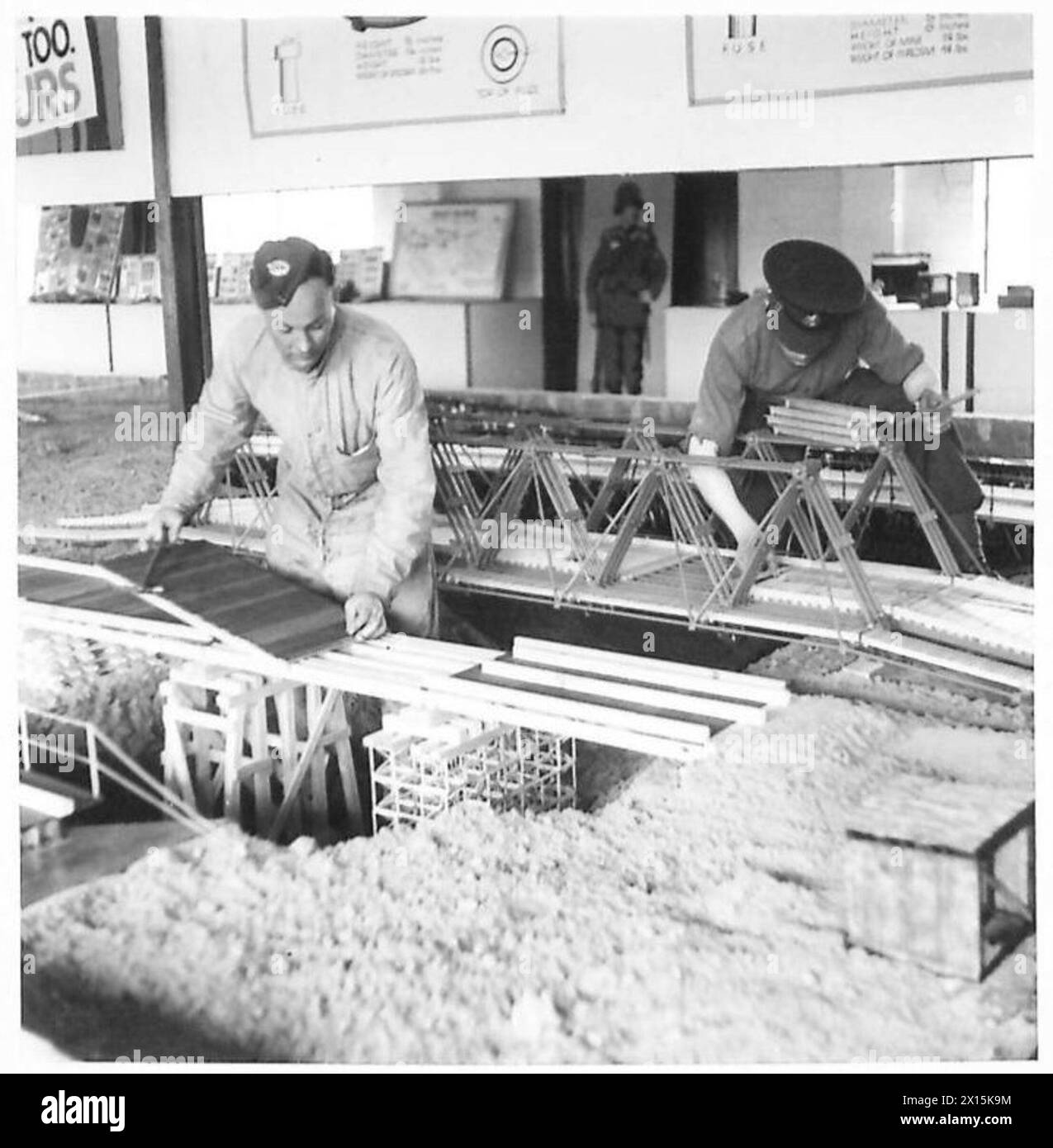 Royal Engineers trainees construct model bridges in a model shop to ...