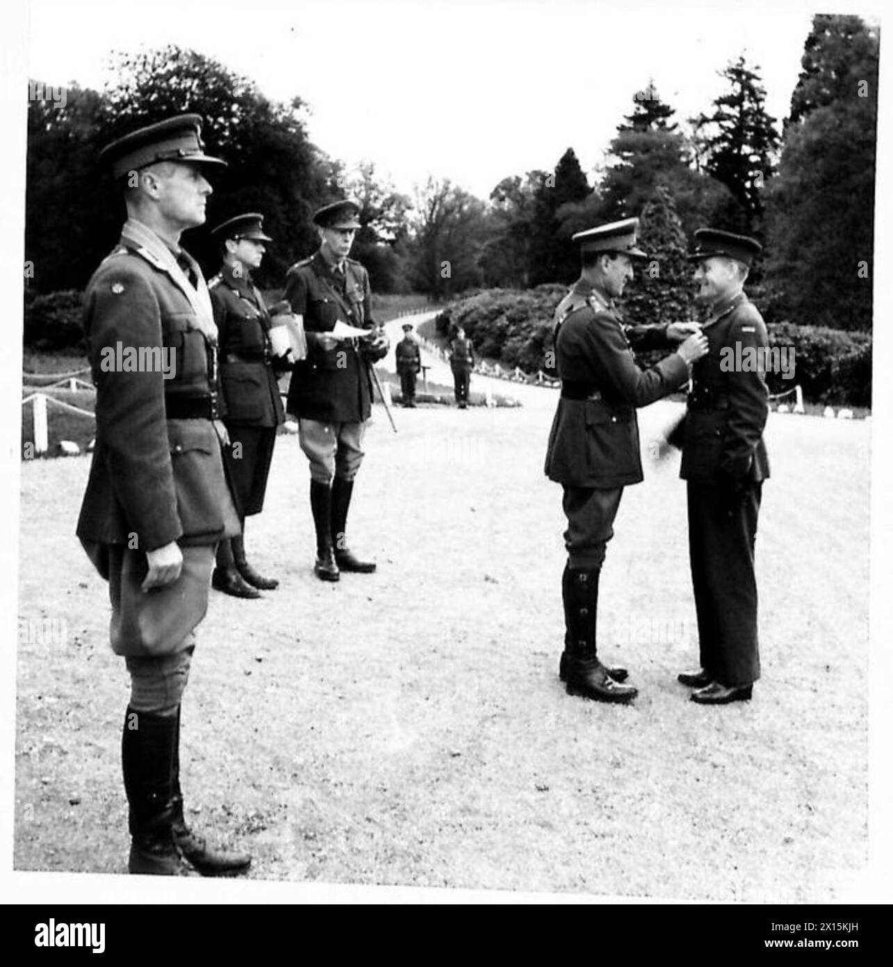 The Commander-in-Chief presents a Norwegian officer with the MBE while ...