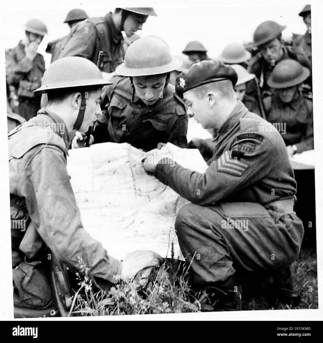 A Sergeant Instructor assists L/Cpl. T. Welsh of Dundee with map ...