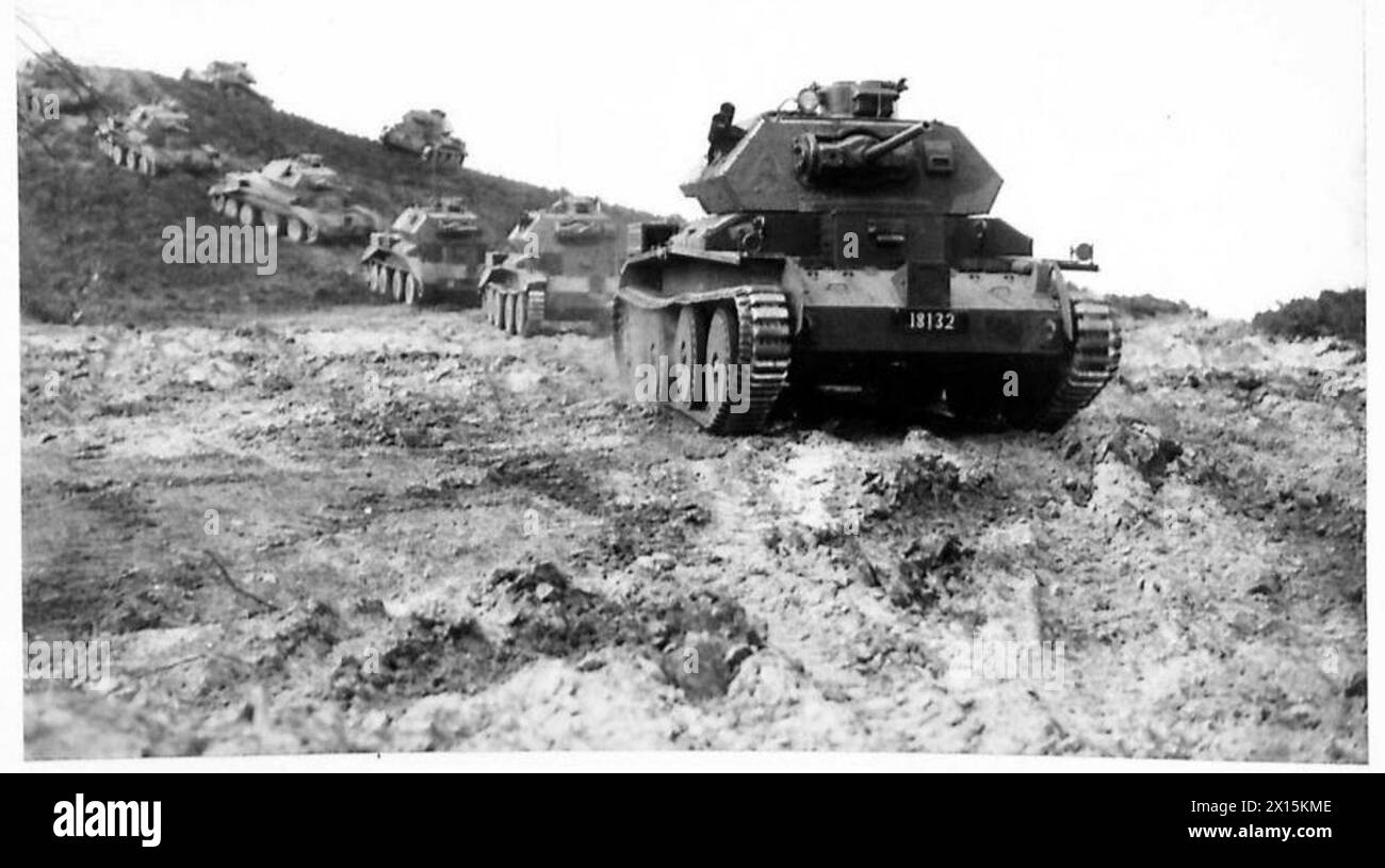 British Army cruiser tanks move in line ahead formation over hilly ...