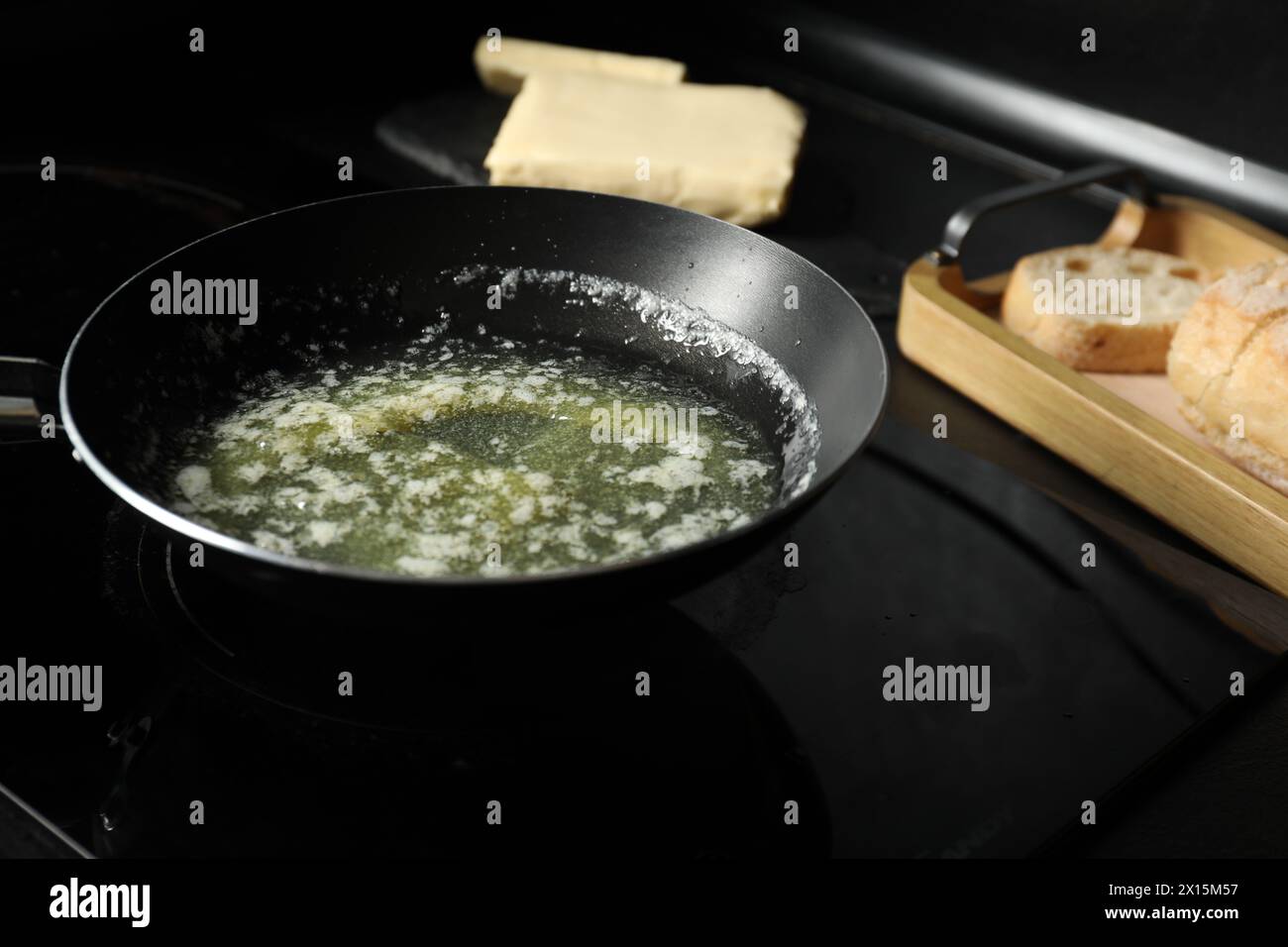 Melting butter in frying pan on cooktop Stock Photo - Alamy