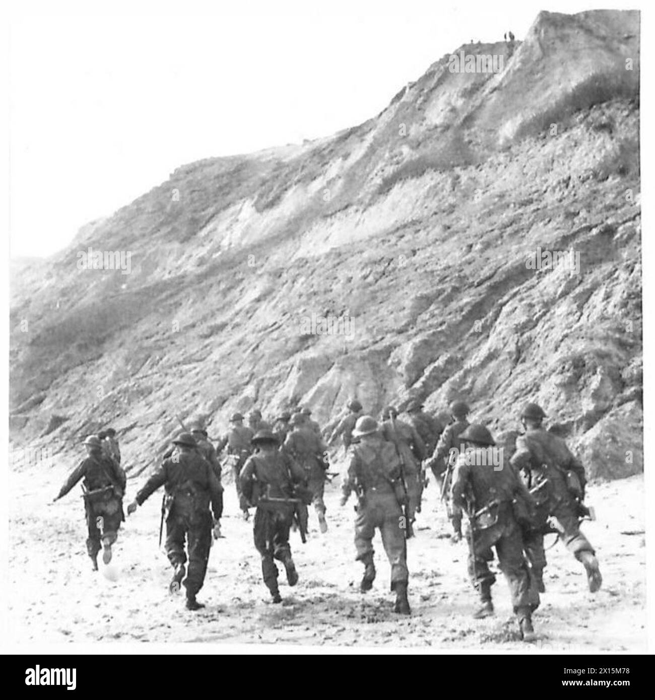 British Army troops participate in battle training, moving quickly to scale cliffs as part of ...