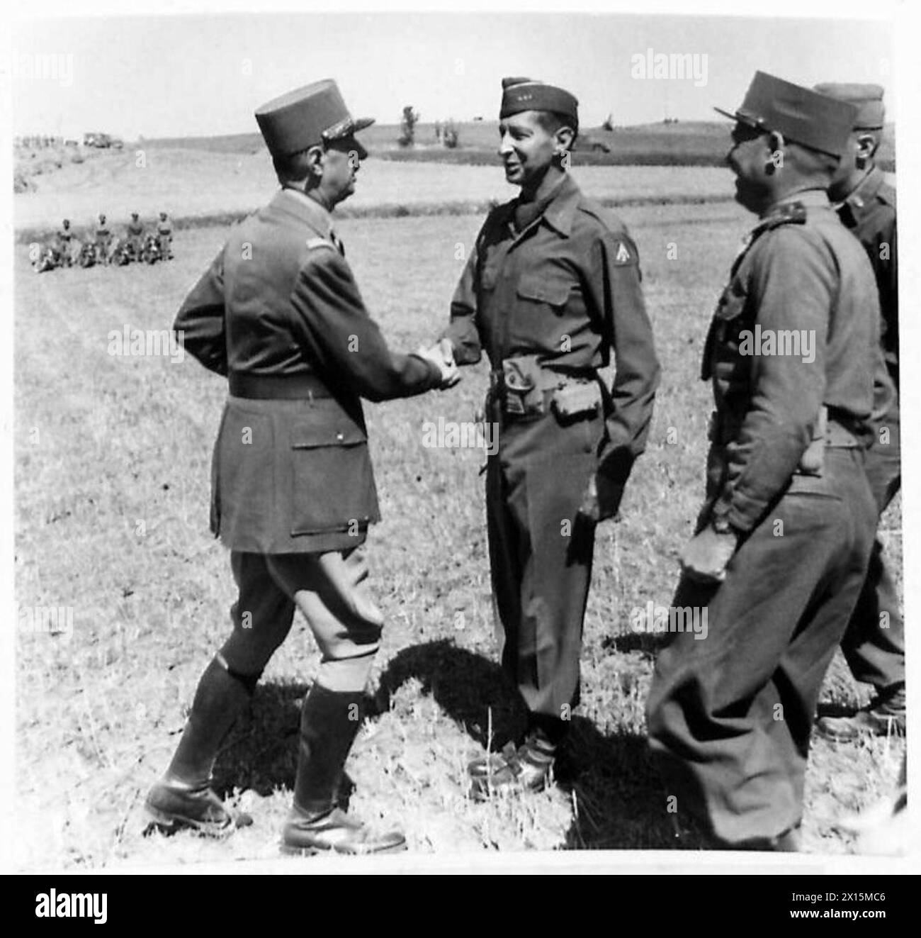 General de Gaulle visits French troops in Italy, shaking hands with ...