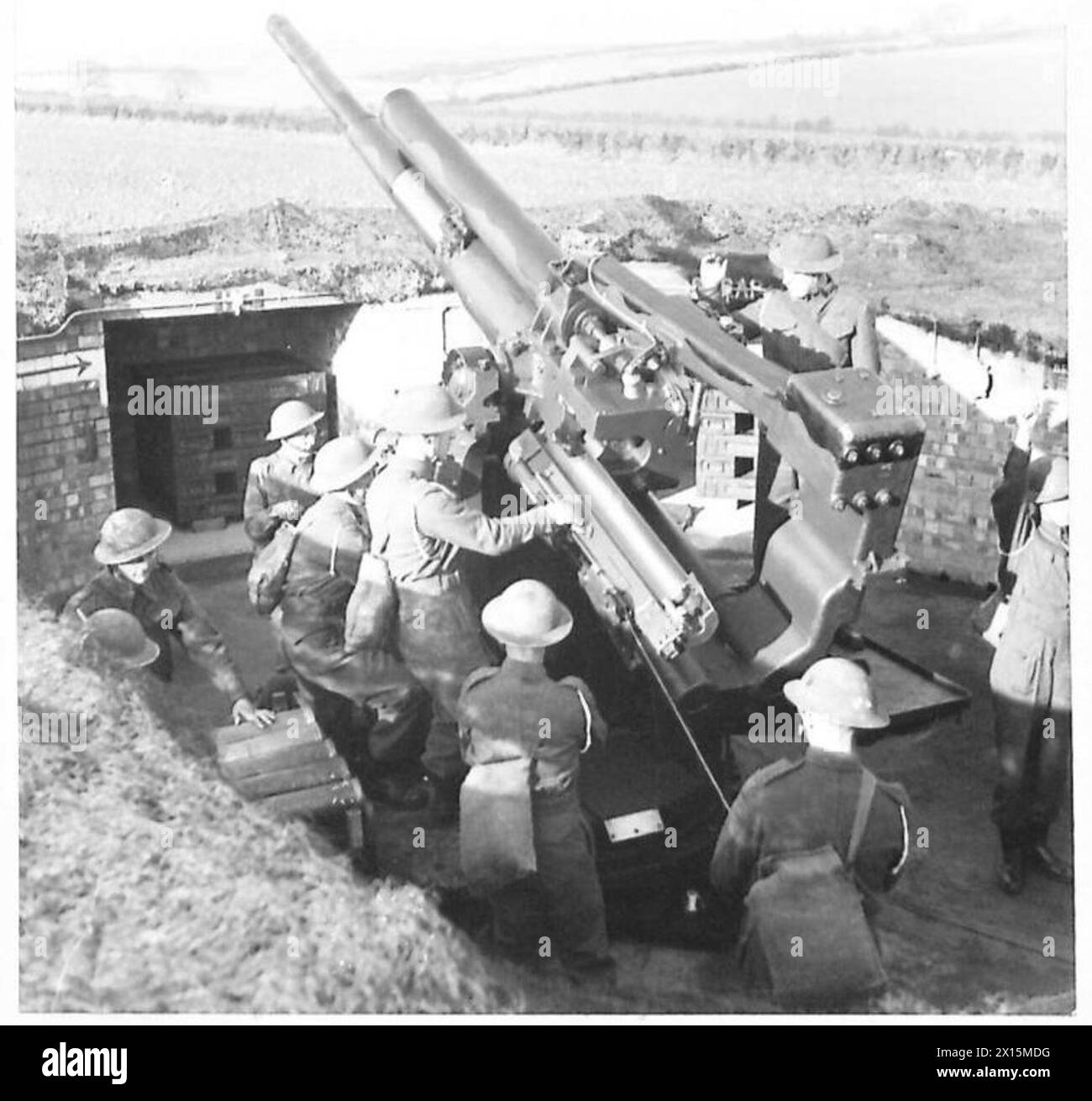 "Gunners operate a 3.7-inch anti-aircraft gun at a British Army A.A ...